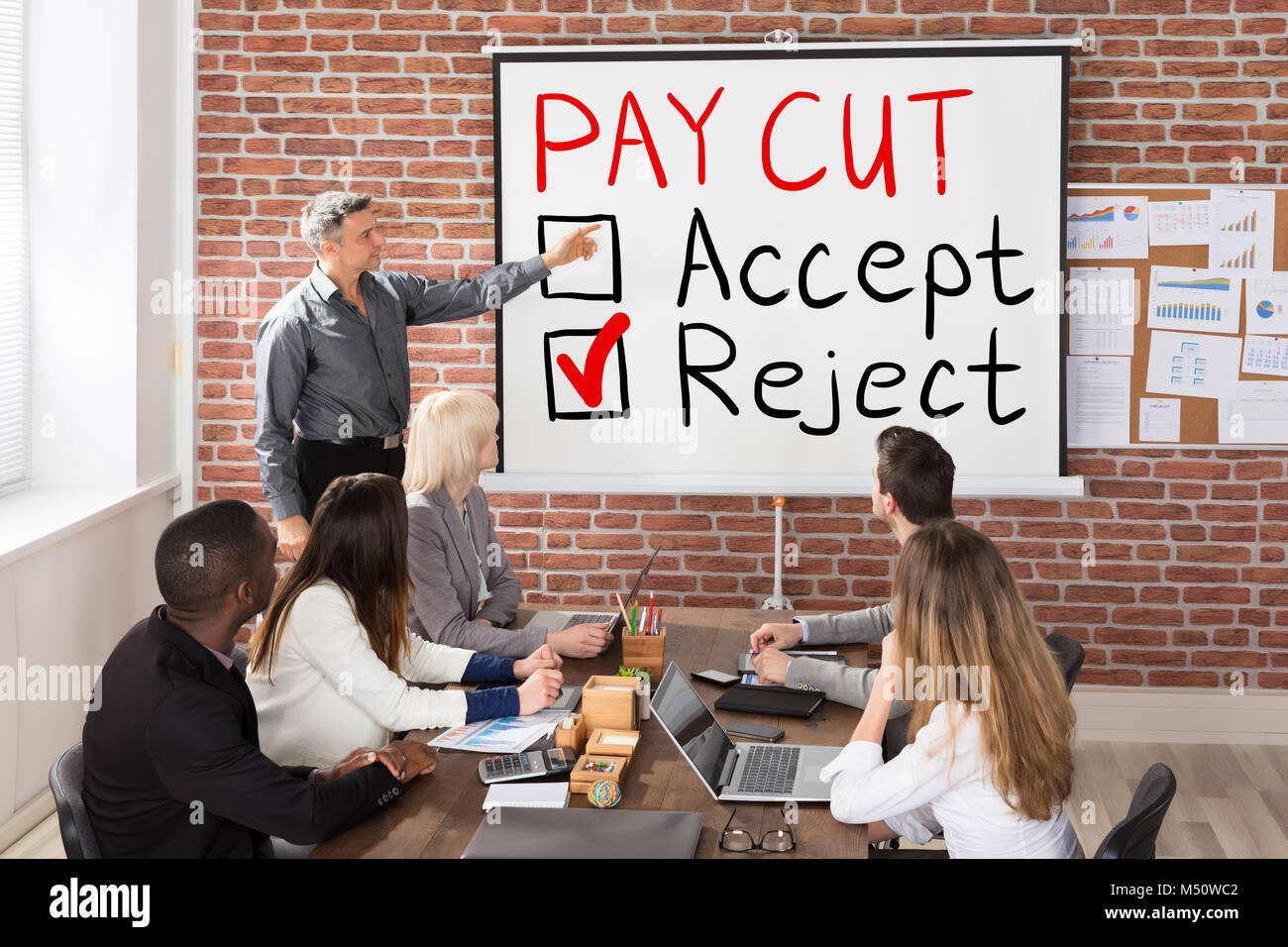 Man Presenting Paycut Rejection Concept To Group Of People Stock Photo ...