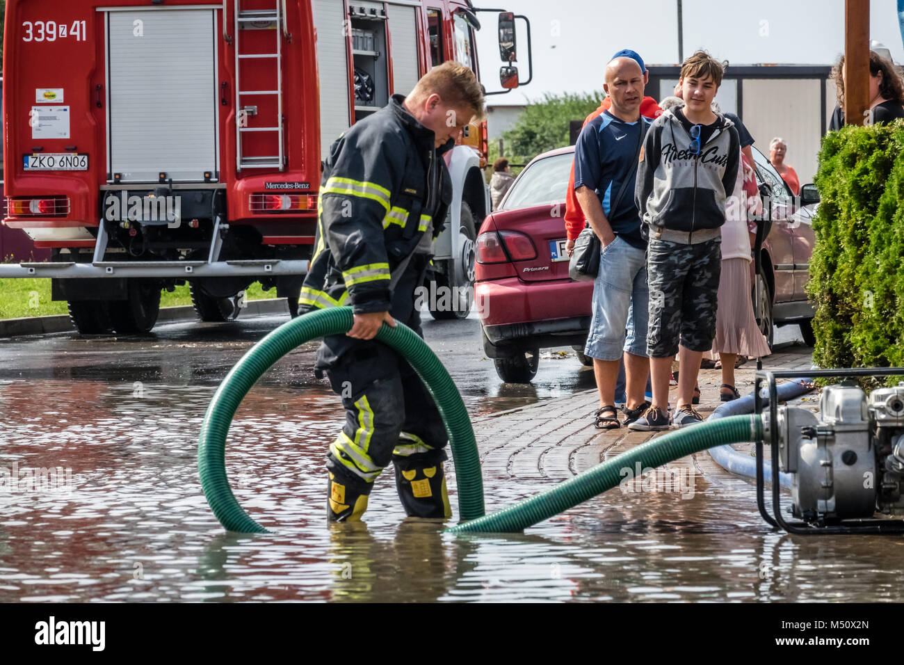 Firefighters pumping out water Stock Photo - Alamy