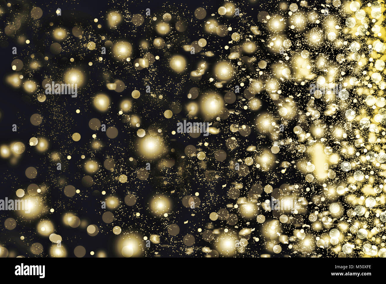 Golden snowflakes swirling on a black background Stock Photo - Alamy
