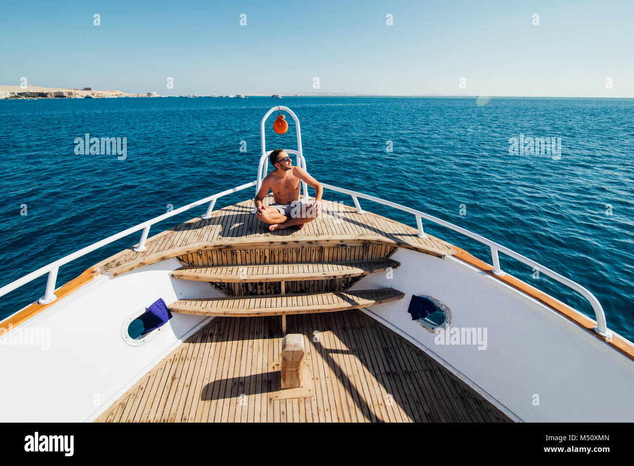 Handsome man on a yacht in the summer, Rest on the yacht, Sits on the ...