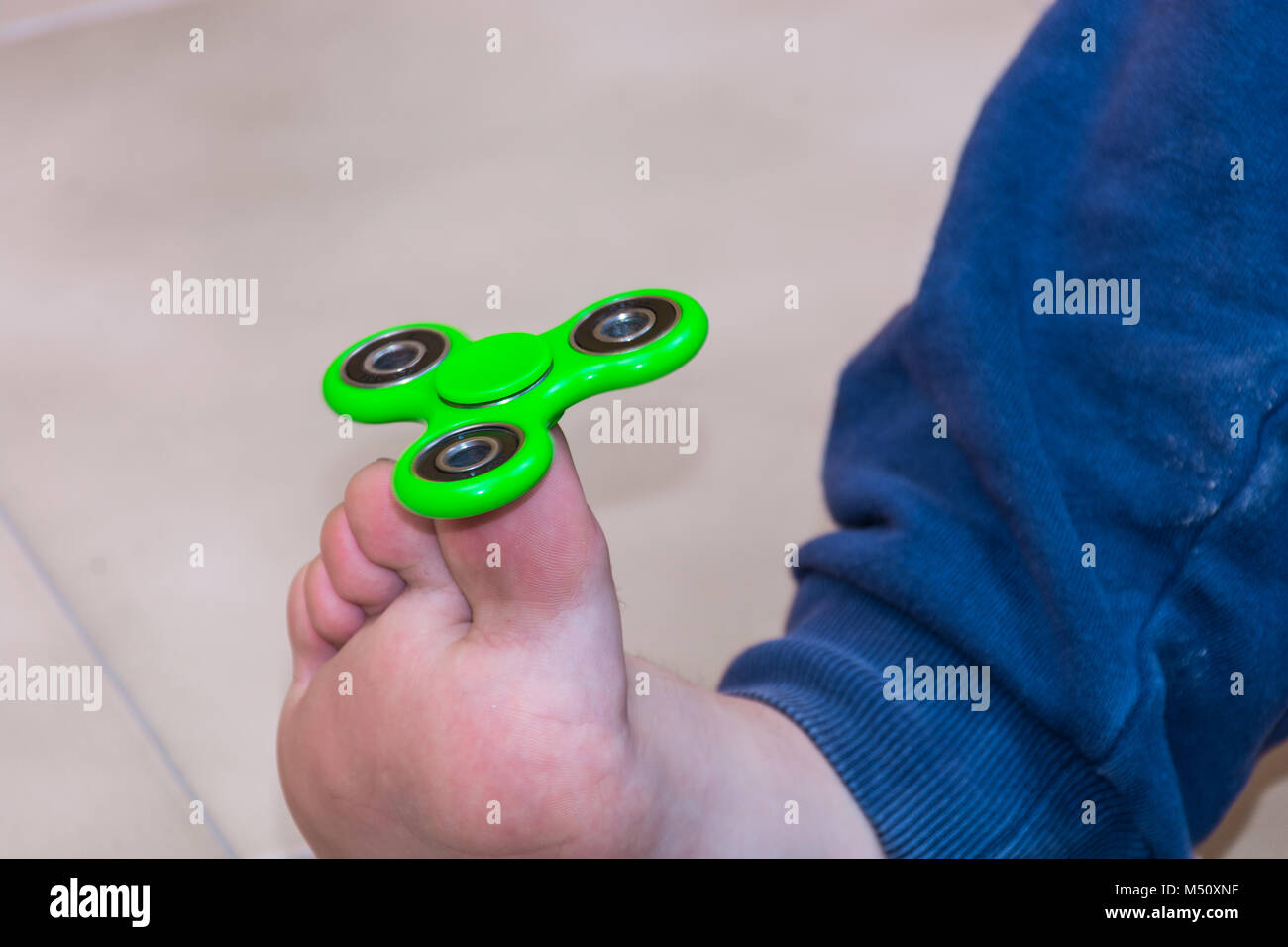Boy playing with fidget spinner gadget. The fidget spinner is a toy, a ...