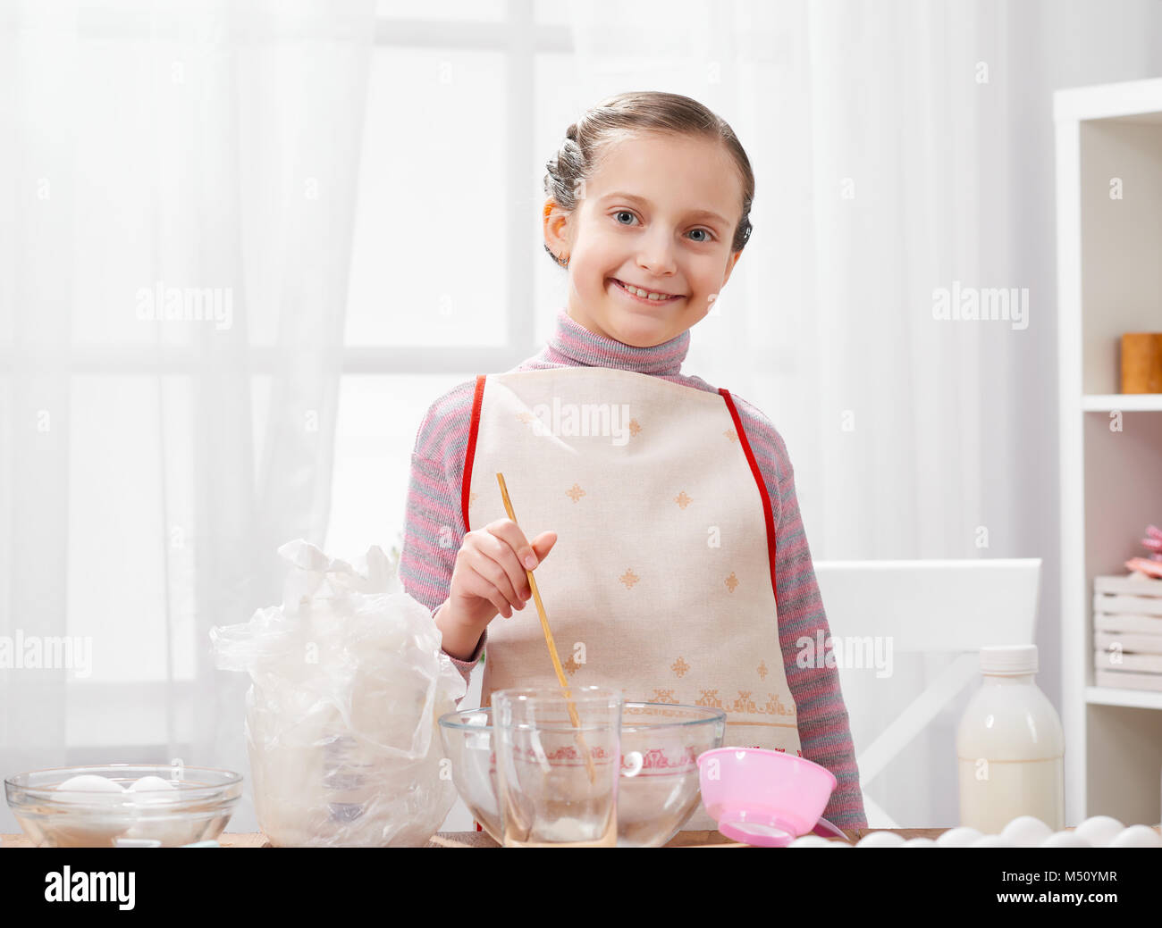 Portrait of girl In kitchen making pastries Stock Photo - Alamy