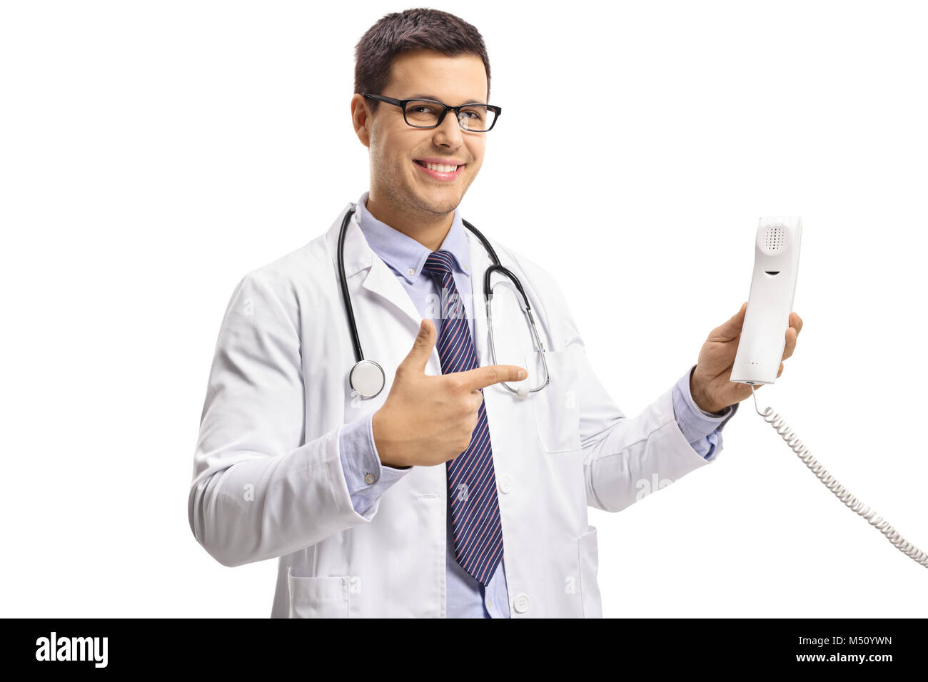 Doctor holding a telephone and pointing isolated on white background ...