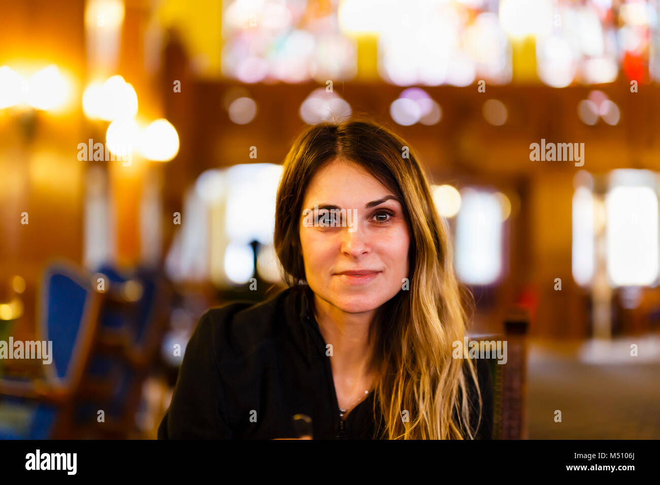 portrait with a positive woman indoors in blur Stock Photo - Alamy
