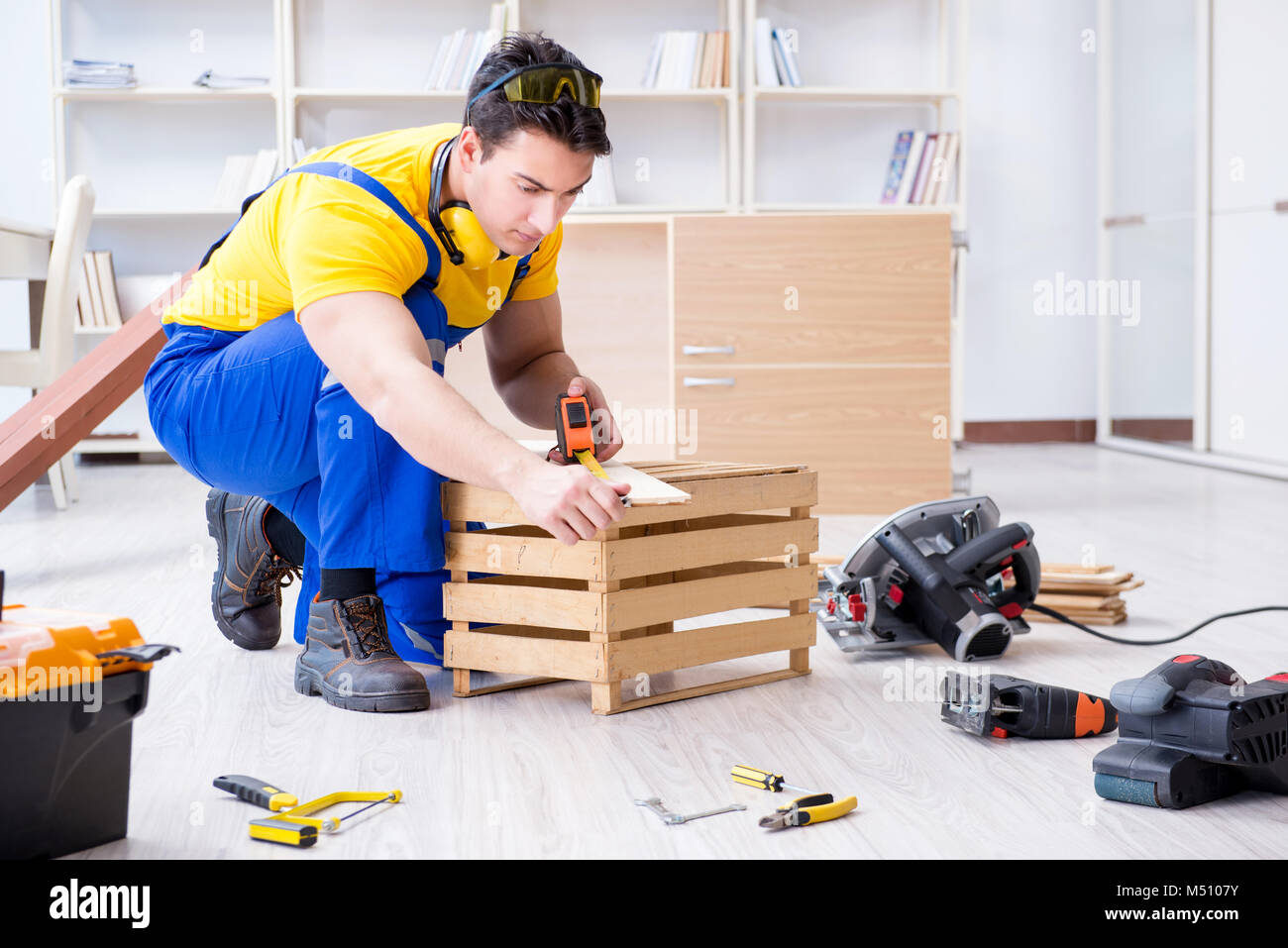 Repairman carpenter working with wooden board plank and measurin Stock ...