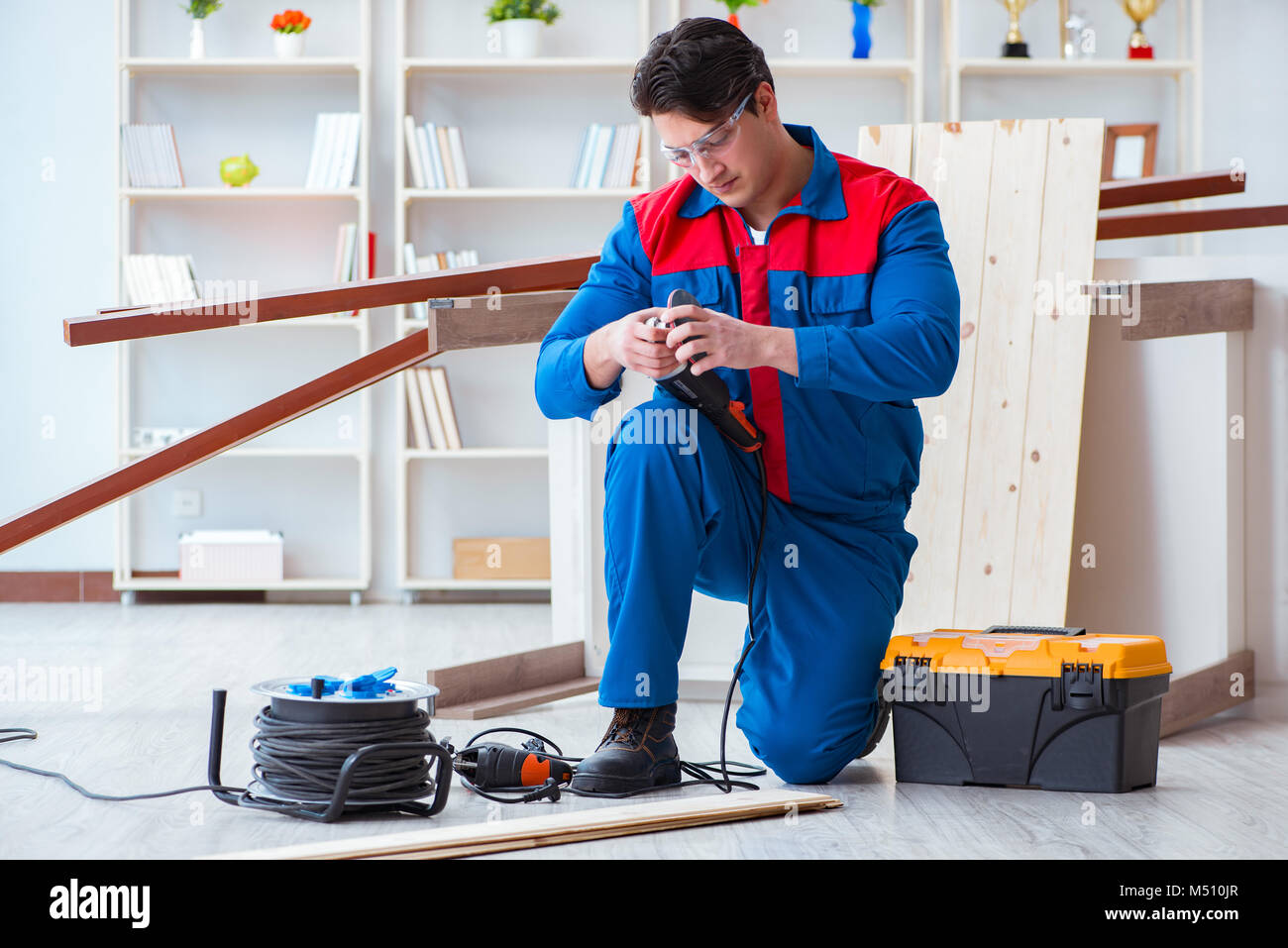 Young carpenter working with wooden planks Stock Photo - Alamy