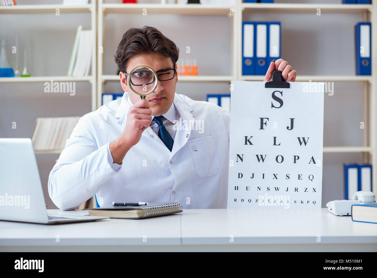 Doctor optician with letter chart conducting an eye test check Stock ...