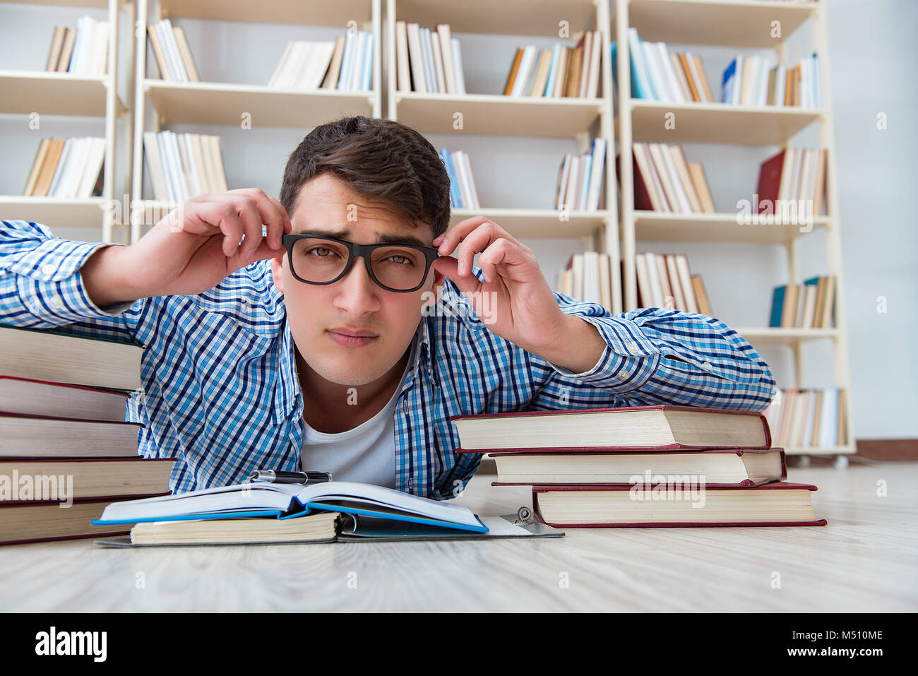 Young student studying with books Stock Photo - Alamy
