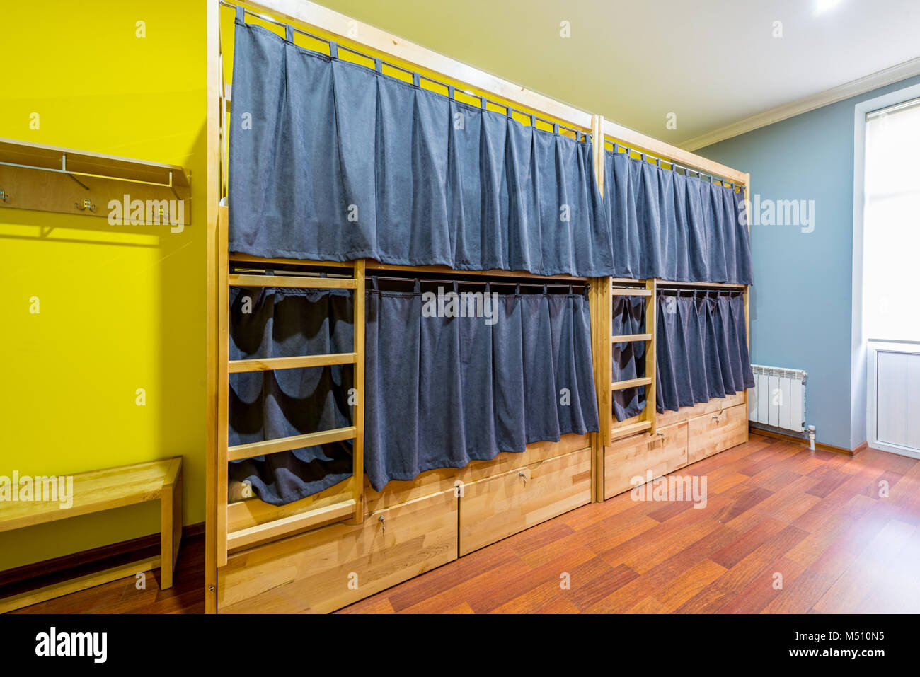 Hostel dormitory beds arranged in room Stock Photo - Alamy