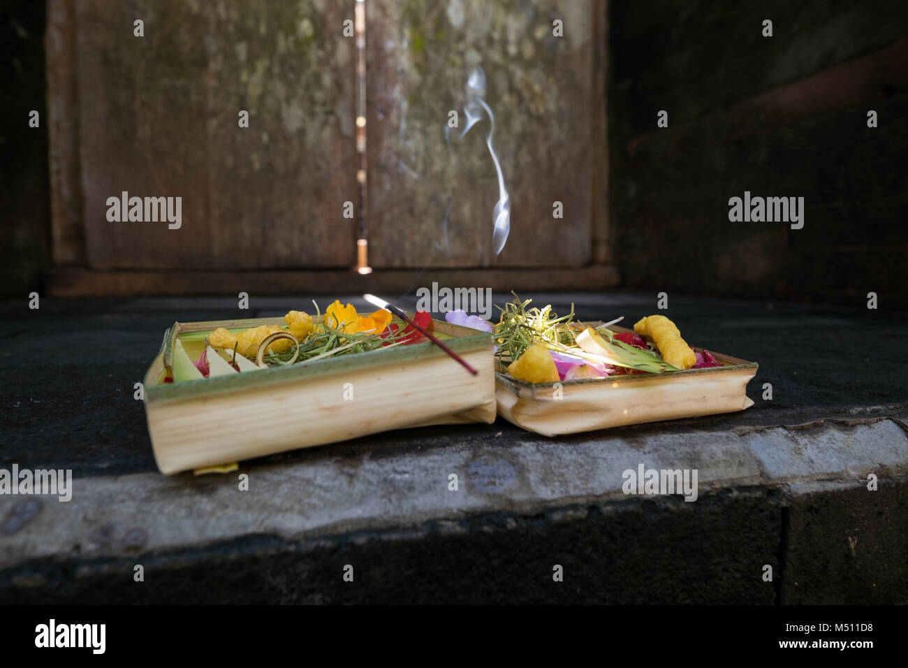 Traditional Balinese flower offerings to God with incense Stock Photo ...