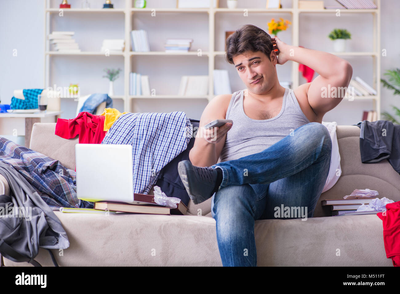 Young man working studying in messy room Stock Photo - Alamy