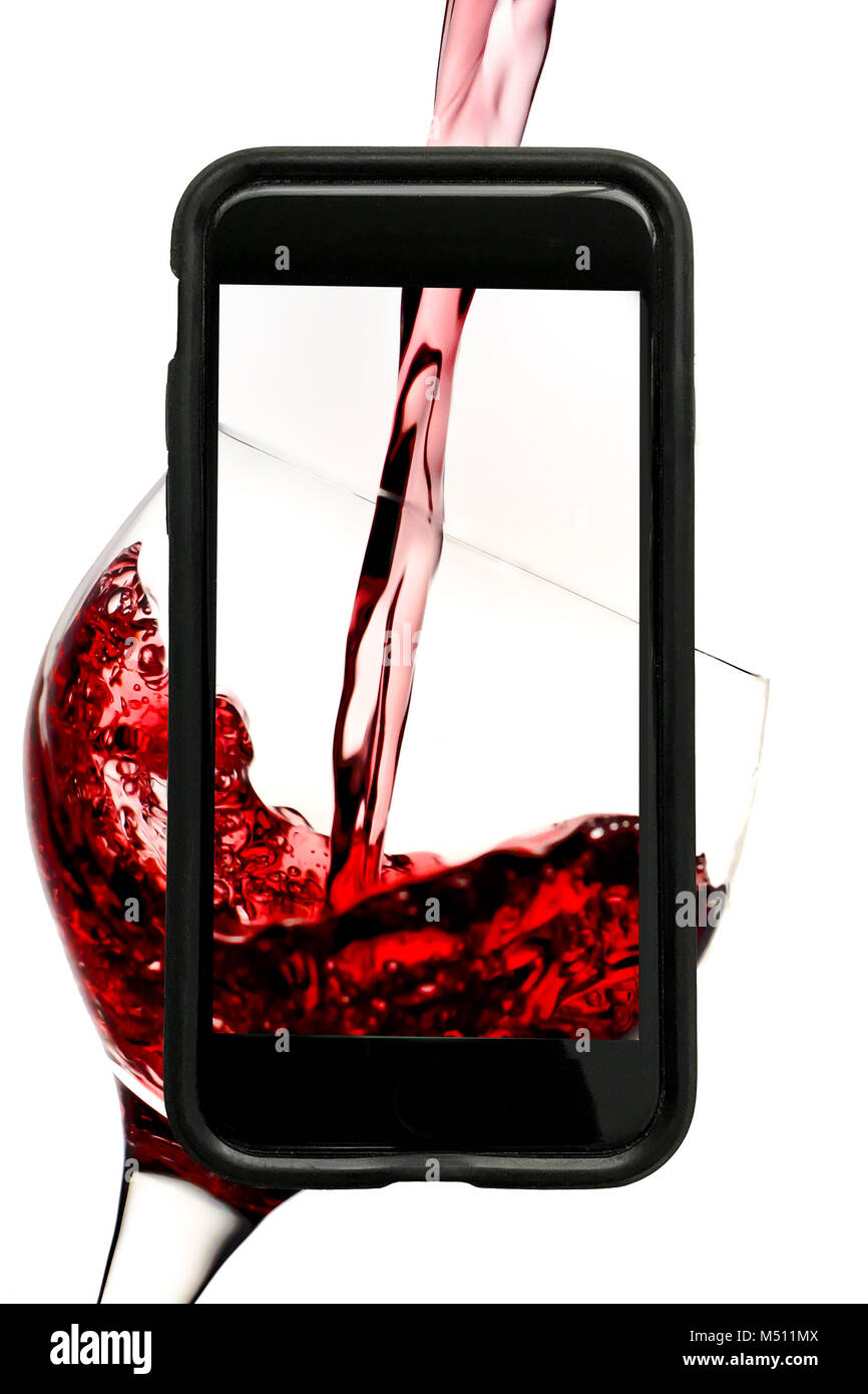 Glass with red wine on white background in the screen of a phone Stock ...