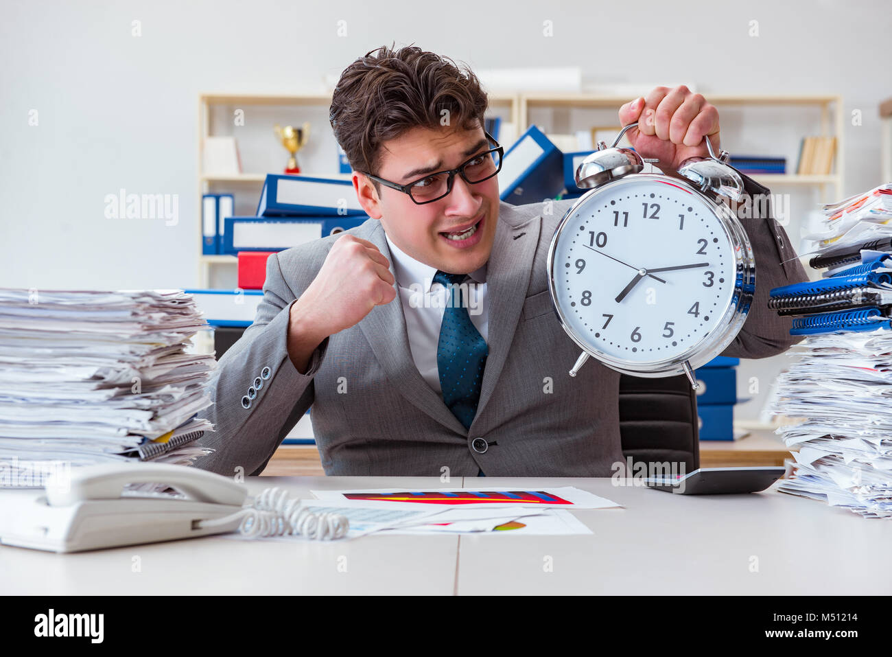 Businessman missing deadlines due to excessive work Stock Photo - Alamy