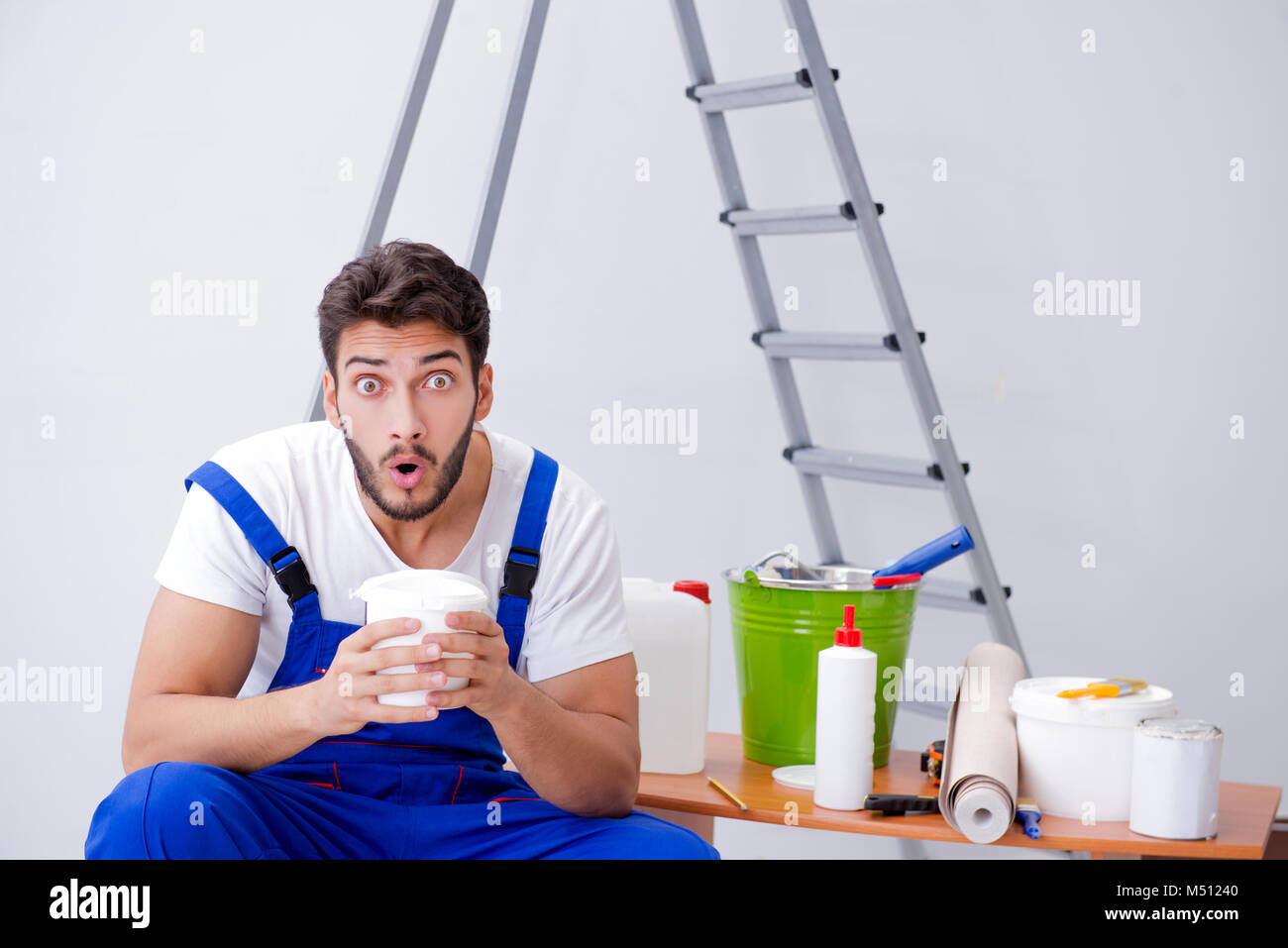 Repairman doing renovation repair in the house with paper wallpa Stock ...
