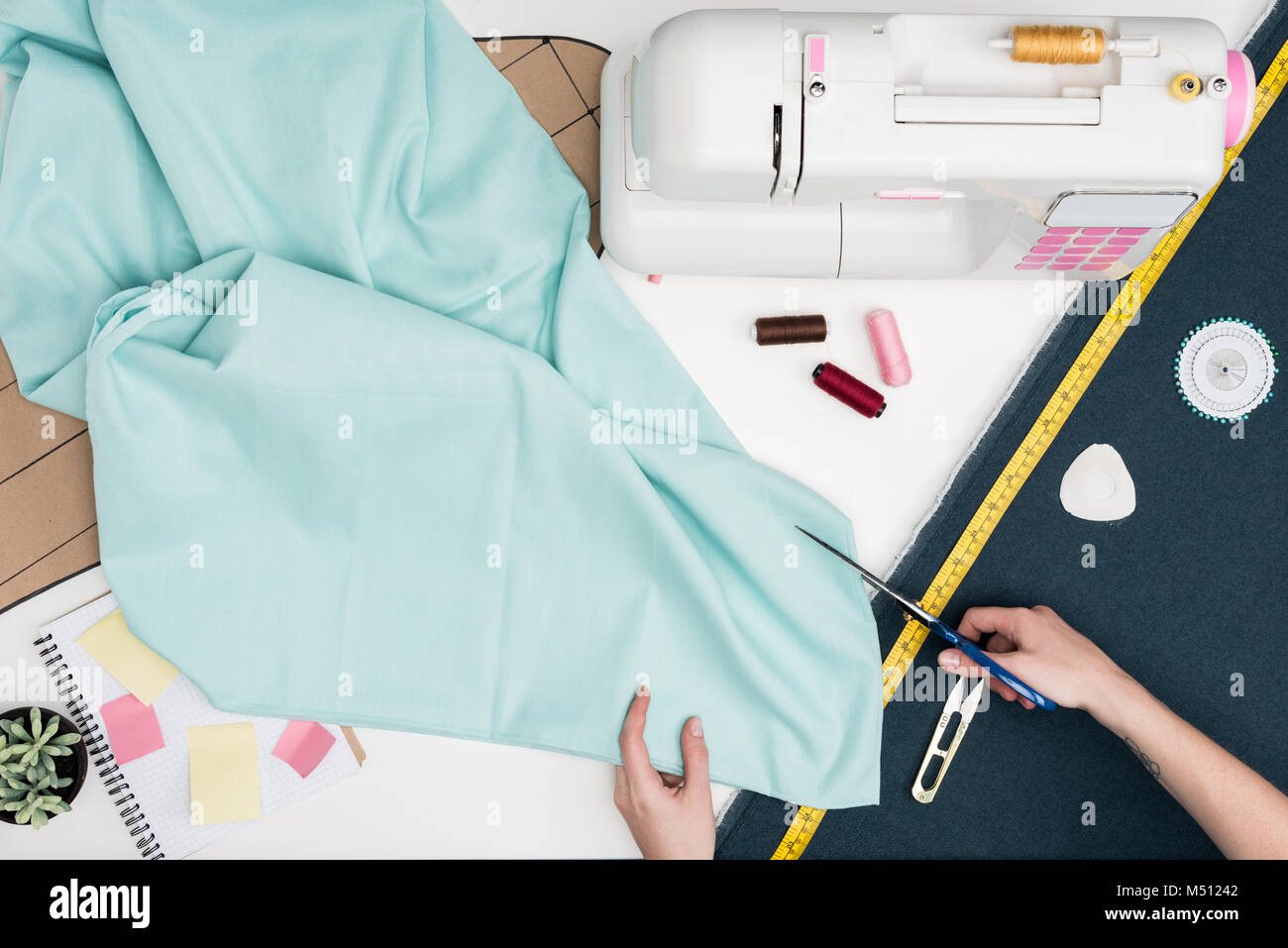 tailor cutting textile with scissors Stock Photo - Alamy