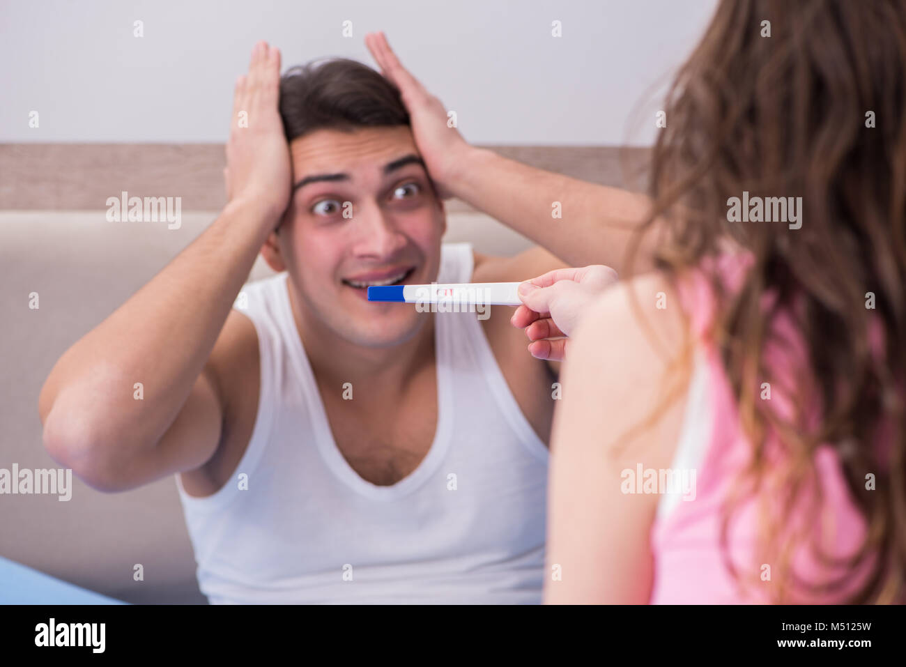 Young family with pregnancy test results Stock Photo - Alamy