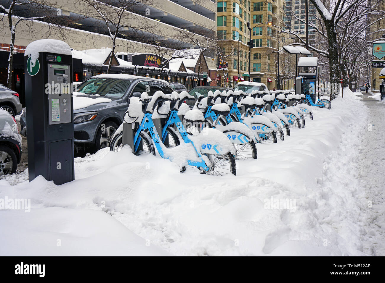 Winter in Chicago. Snow covers Divvy bike shares blue Bixi bicycles ...
