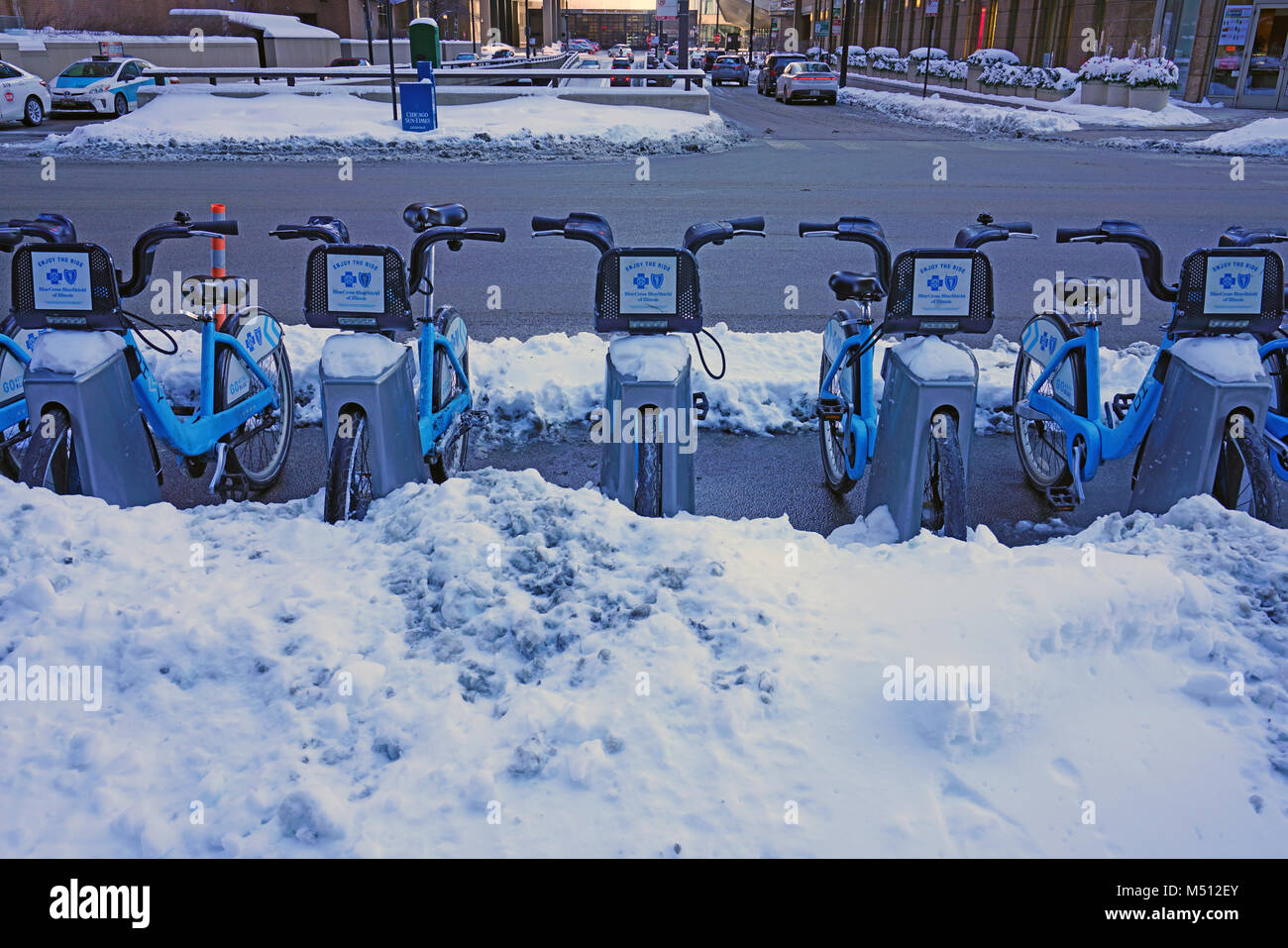 Winter in Chicago. Snow covers Divvy bike shares blue Bixi bicycles ...