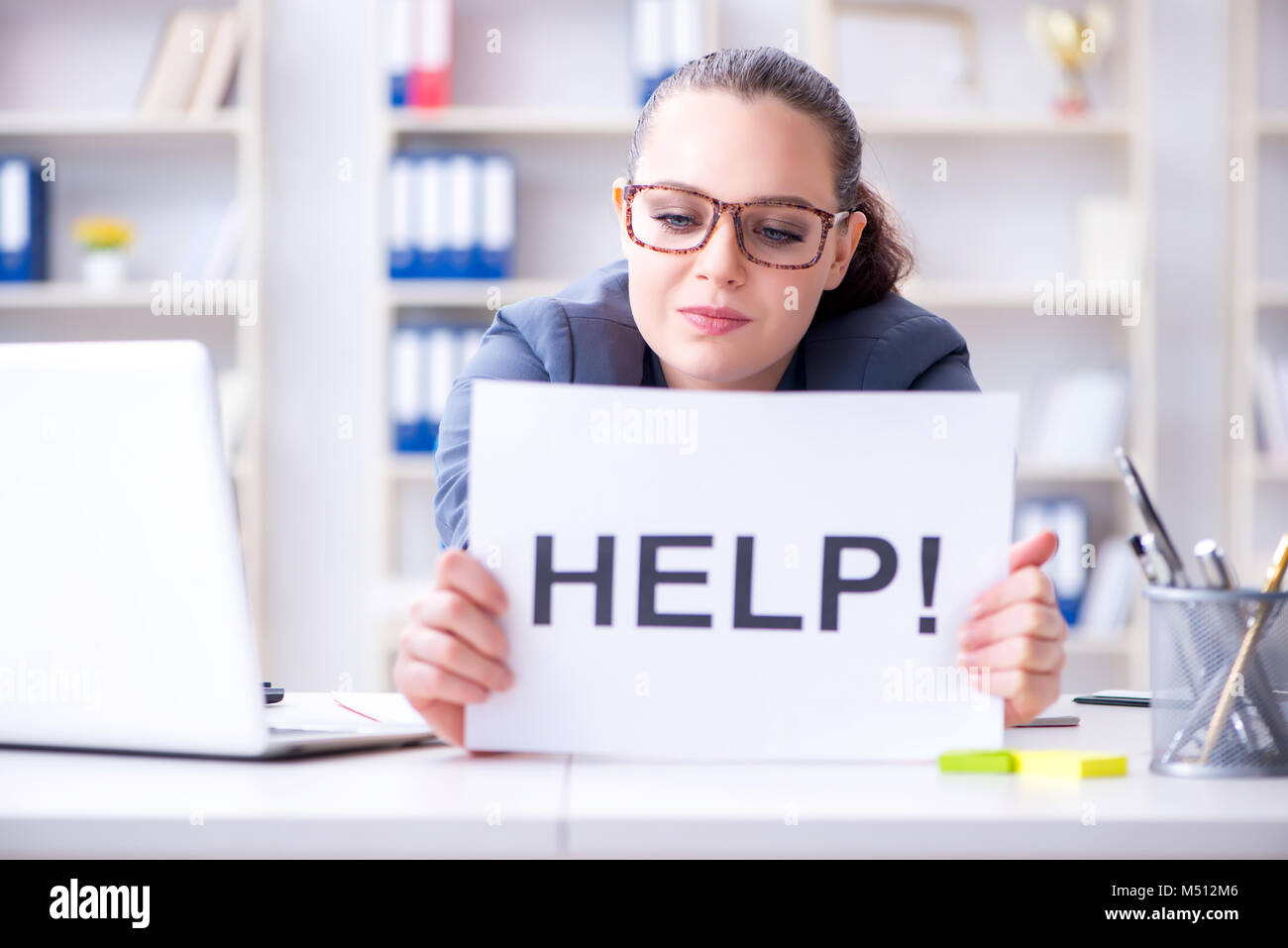 Businesswoman pleading for help in office Stock Photo - Alamy