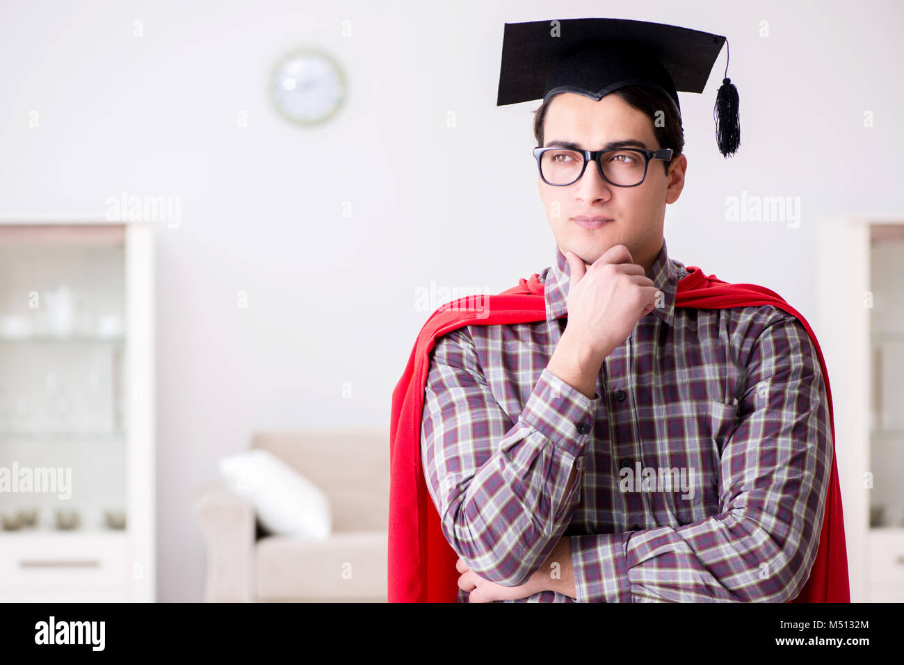 Super hero student wearing mortarboard in a red cloak Stock Photo - Alamy