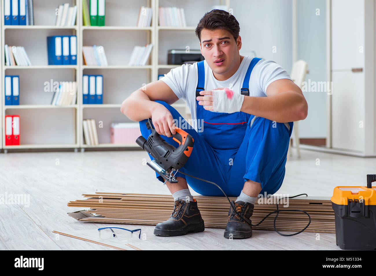 Young worker working on floor laminate tiles Stock Photo - Alamy