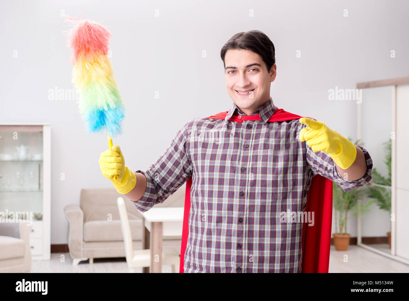 The super hero cleaner doing housework Stock Photo - Alamy