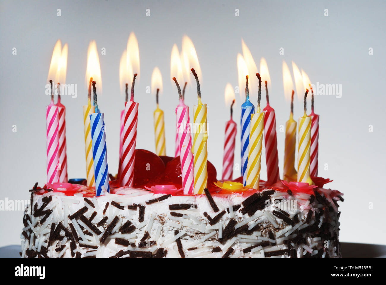 a birthday cake with lighted candles Stock Photo - Alamy