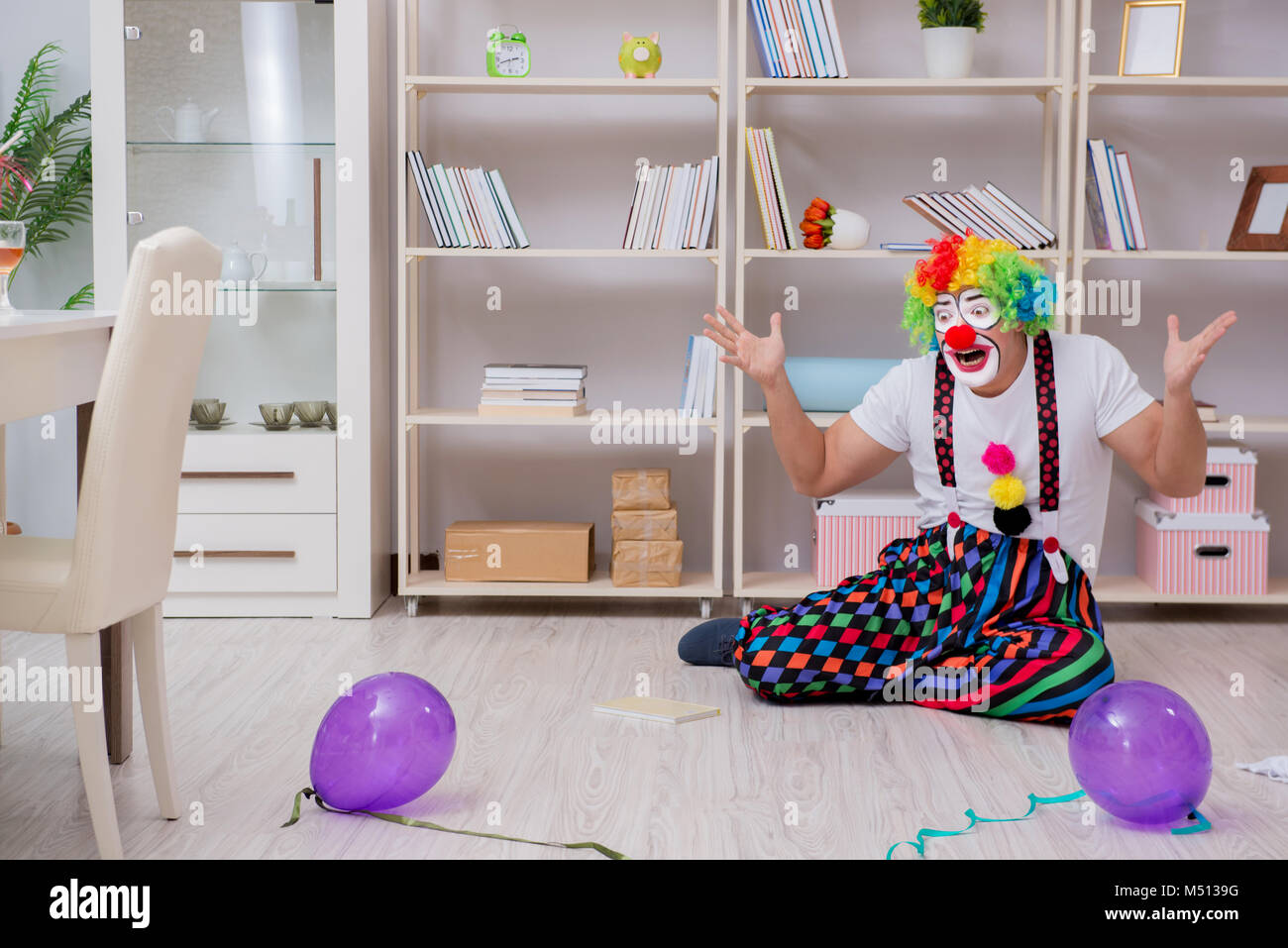 Drunk clown celebrating having a party at home Stock Photo - Alamy
