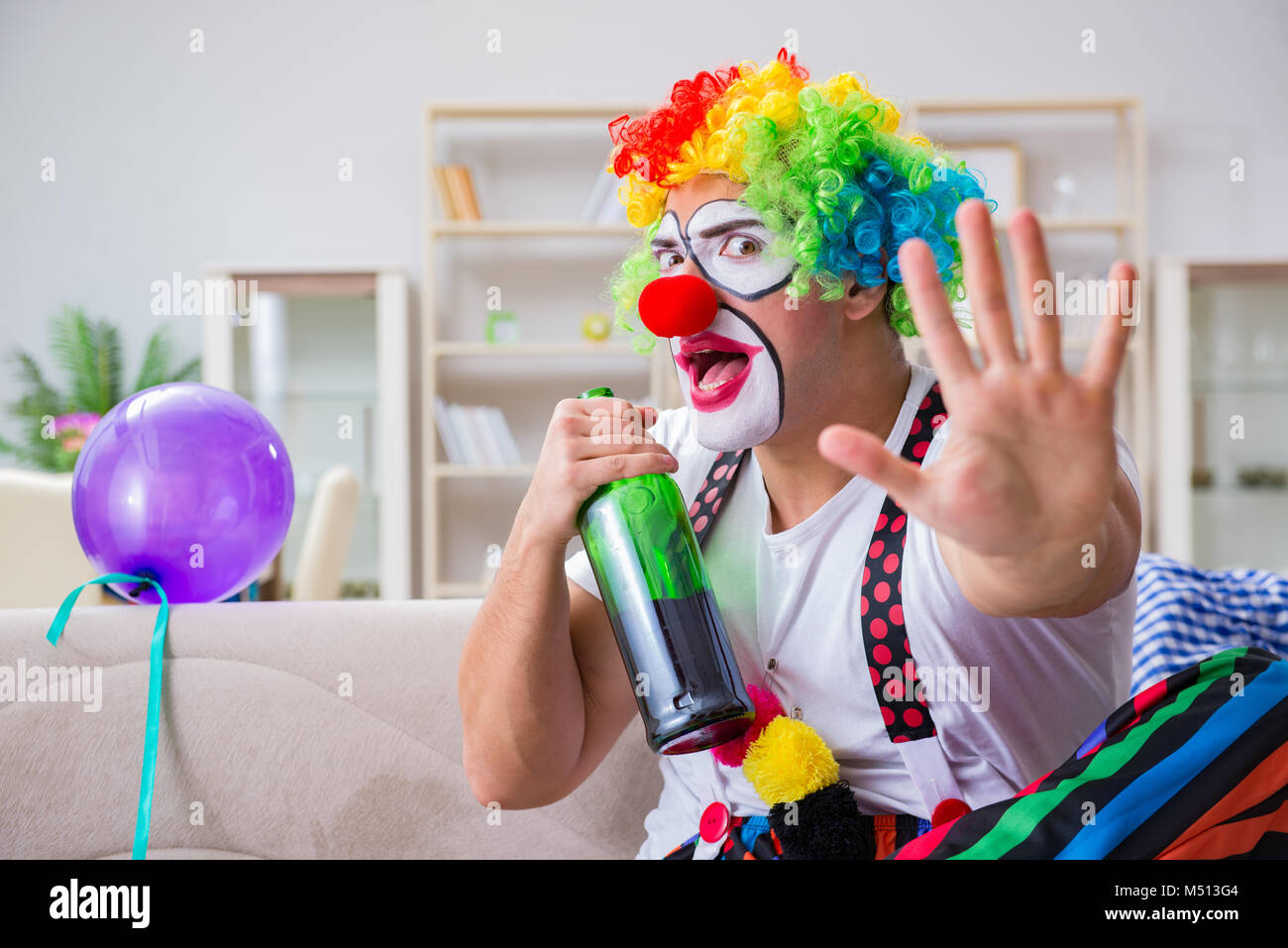 Drunk clown celebrating having a party at home Stock Photo - Alamy