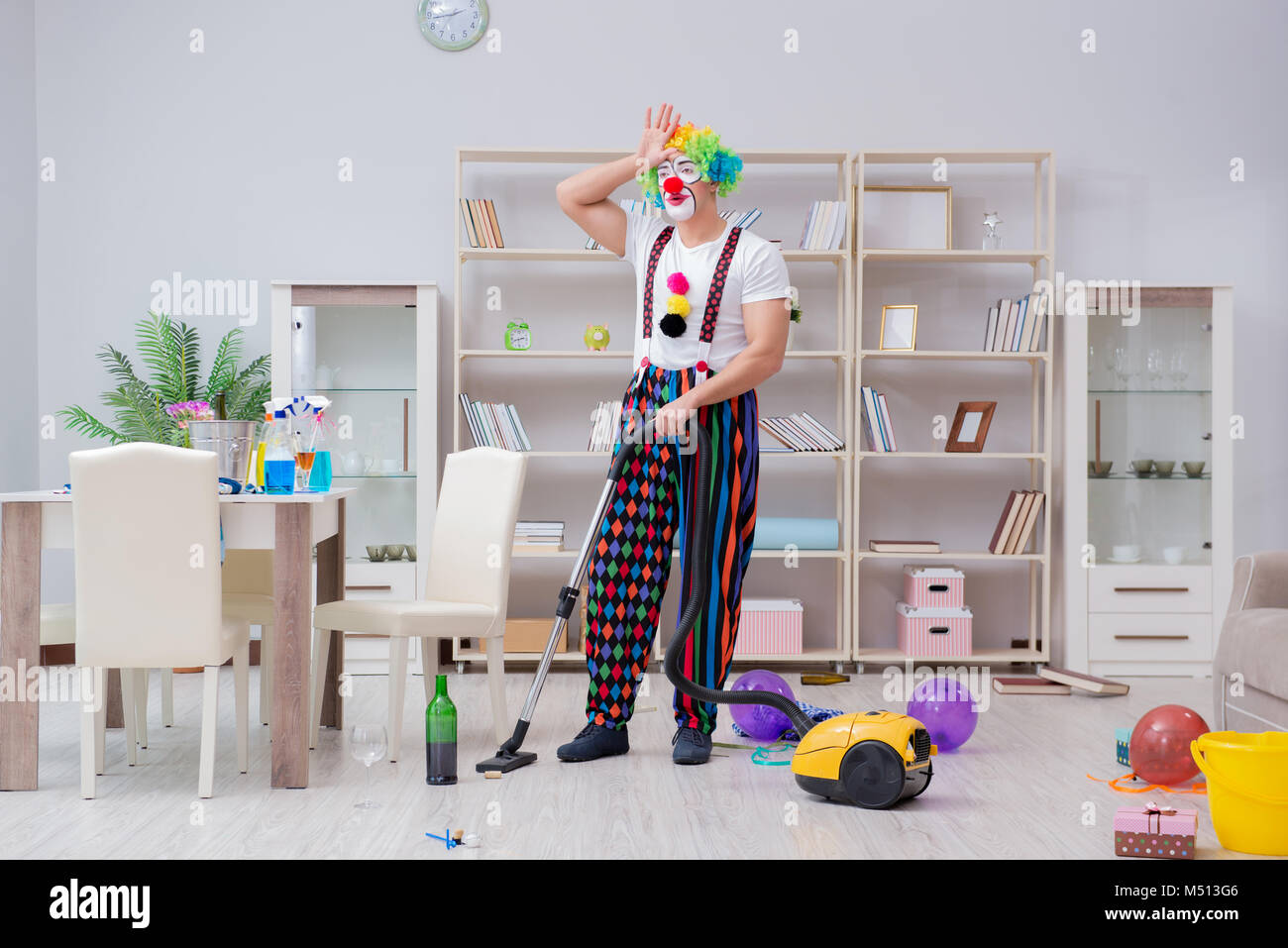 Funny clown doing cleaning at home Stock Photo - Alamy