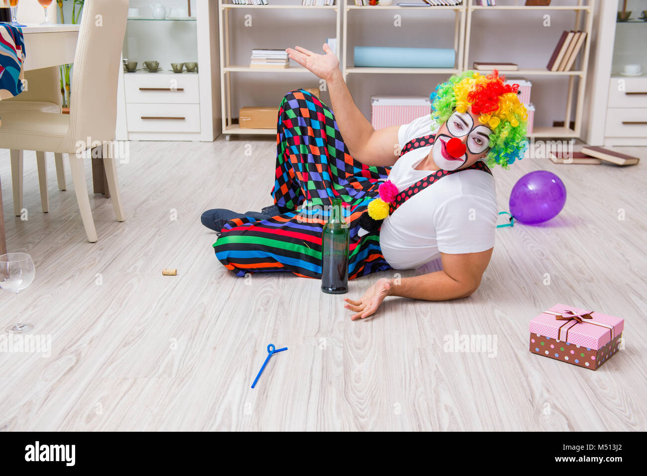 Drunk clown celebrating having a party at home Stock Photo - Alamy