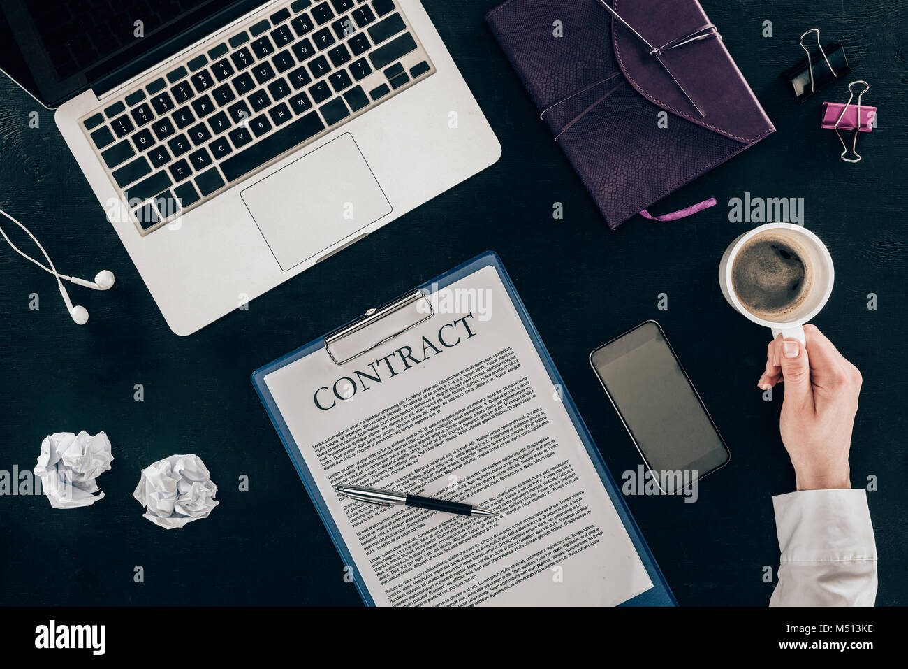 cropped shot of businesswoman drinking coffee at workplace with ...
