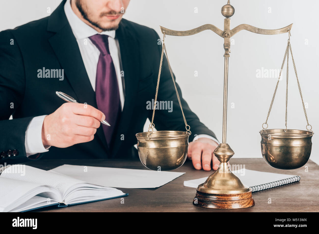 cropped shot of lawyer doing paperwork at workplace with scales Stock ...