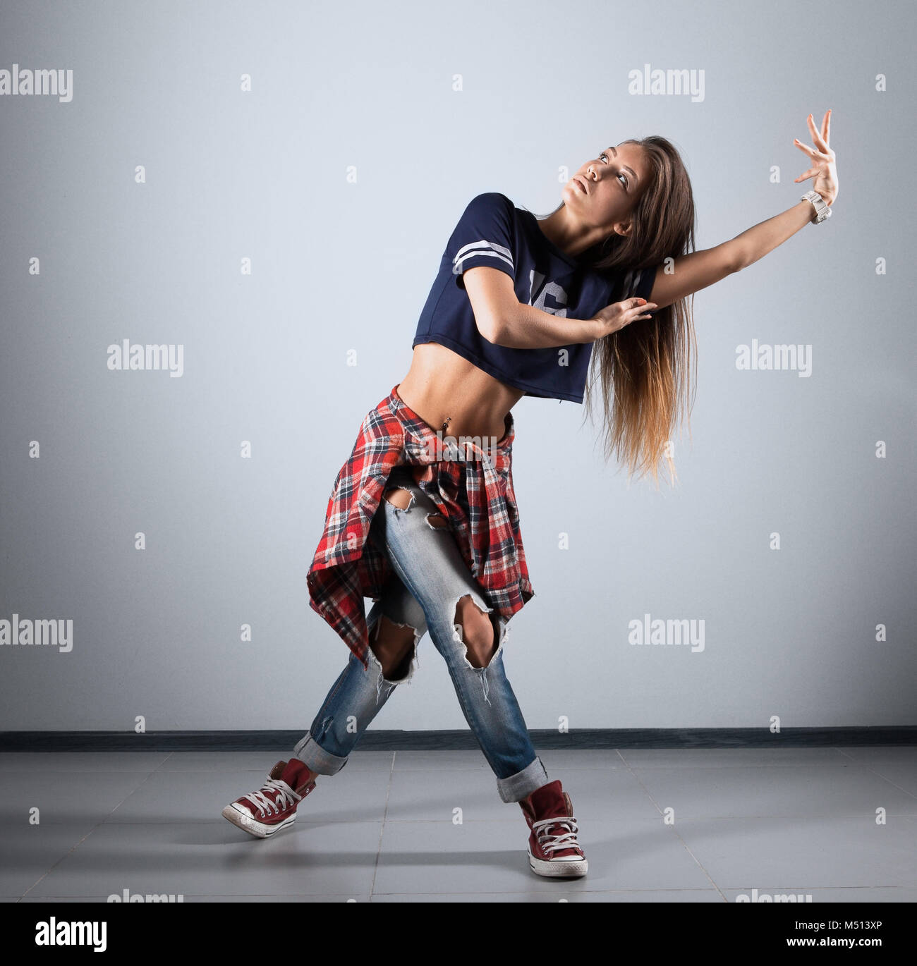 modern young beautiful dancer posing on a studio background Stock Photo ...