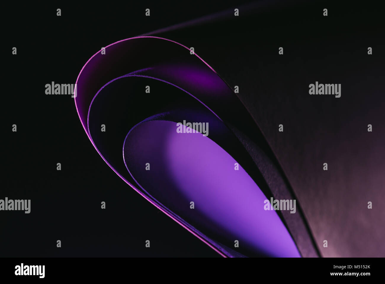 arcs of warping purple paper on black Stock Photo - Alamy