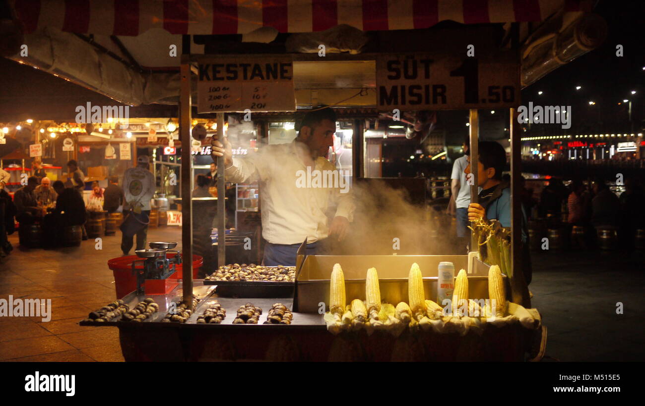 A street vendor selling corn on the cob at night time in Istanbul ...