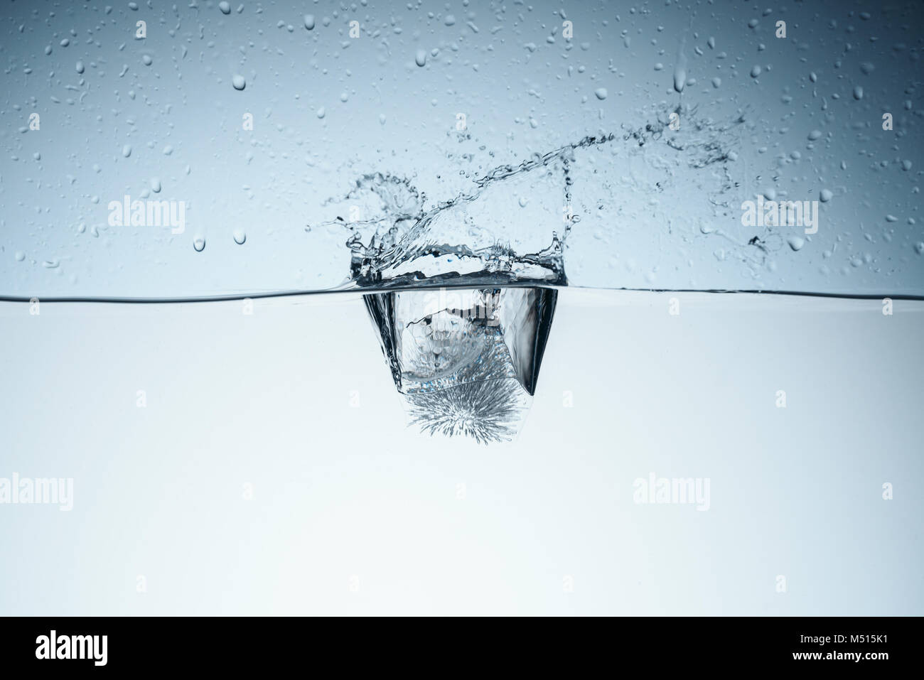 ice cube in water with splash and drops, isolated on white Stock Photo ...