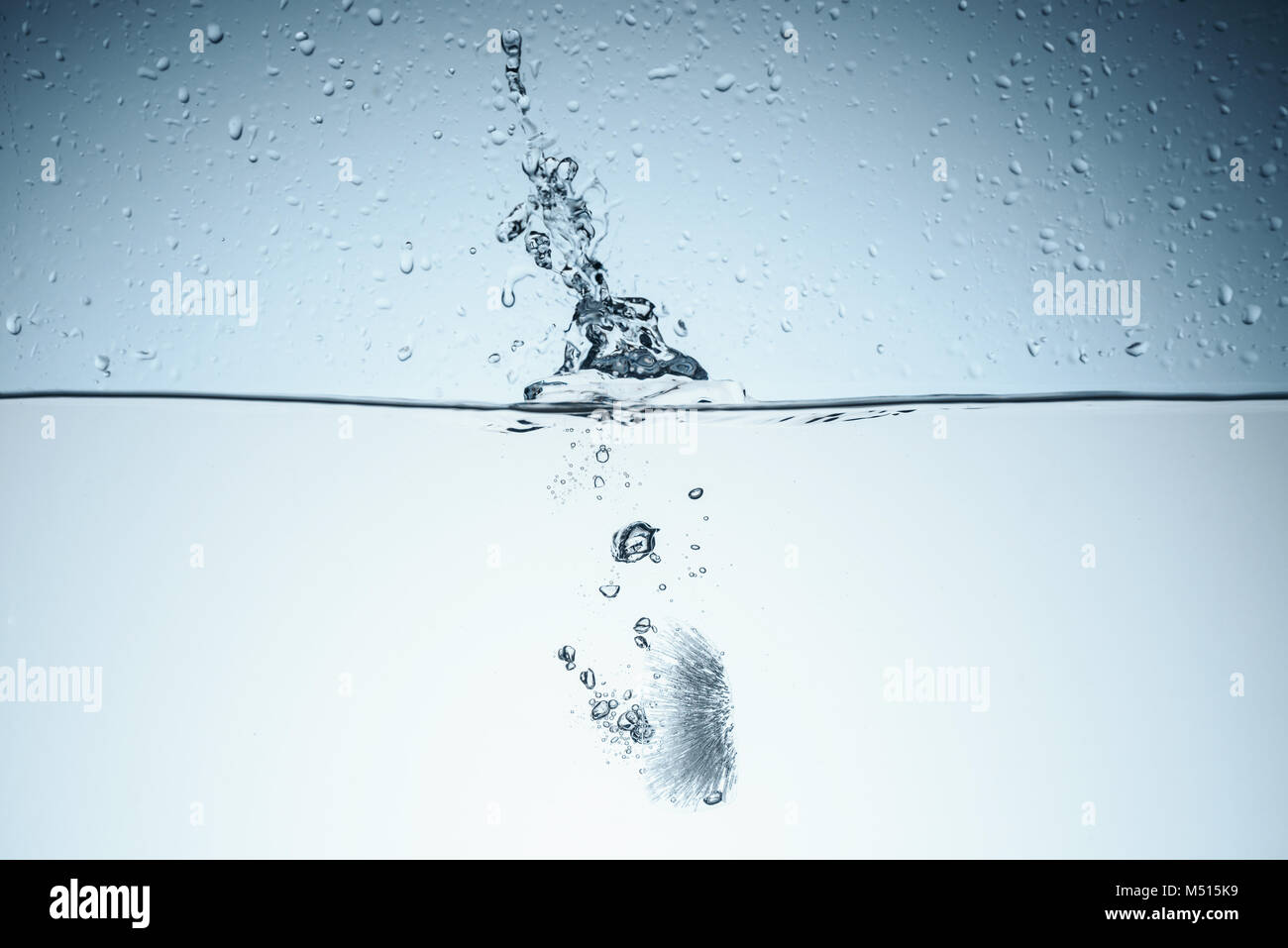 ice cube in water with splash, isolated on white Stock Photo - Alamy