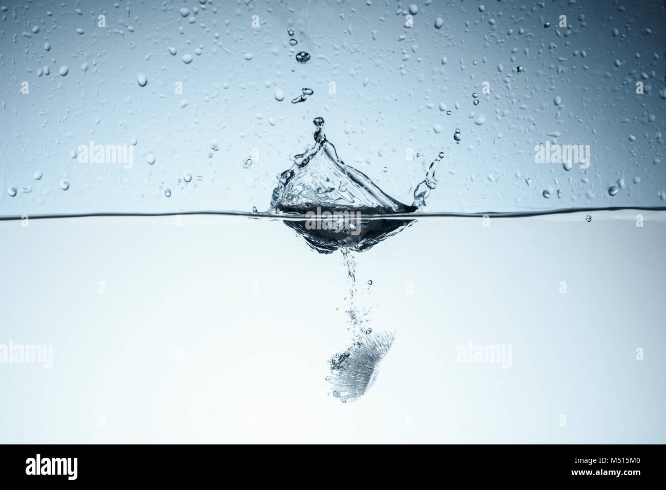 ice cube in pure water with splash, isolated on white Stock Photo - Alamy