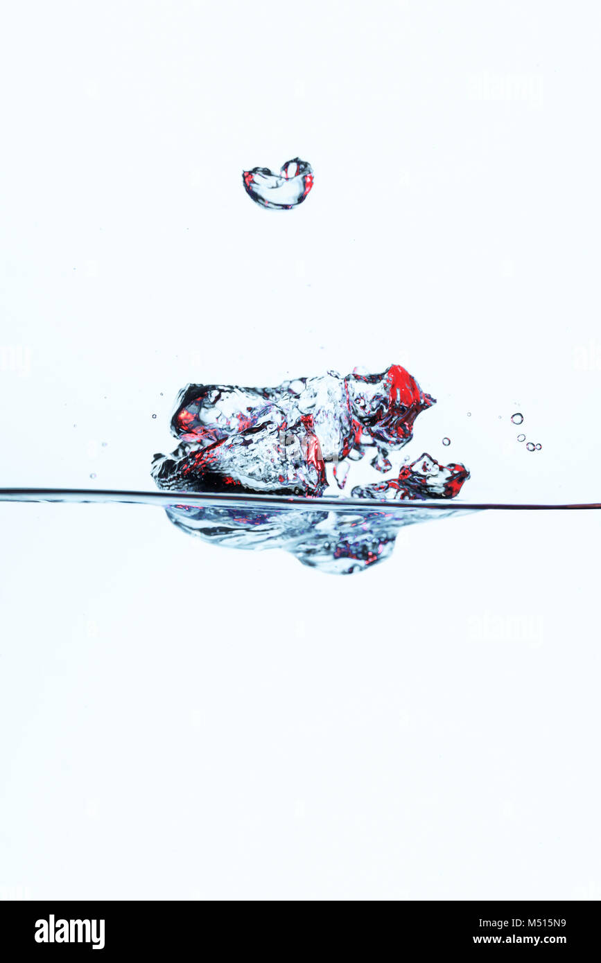 ice cubes in water with bubbles, isolated on white Stock Photo - Alamy