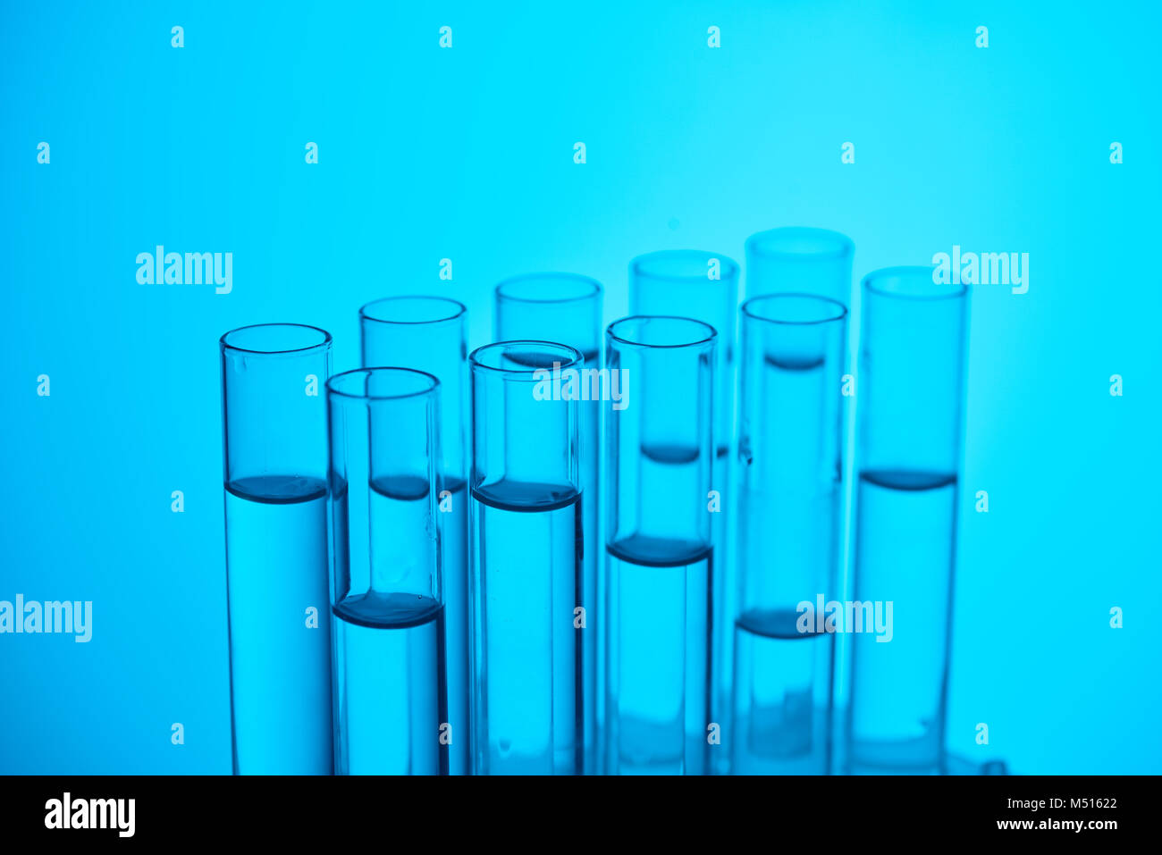 glass tubes with liquid for chemical test on blue Stock Photo - Alamy