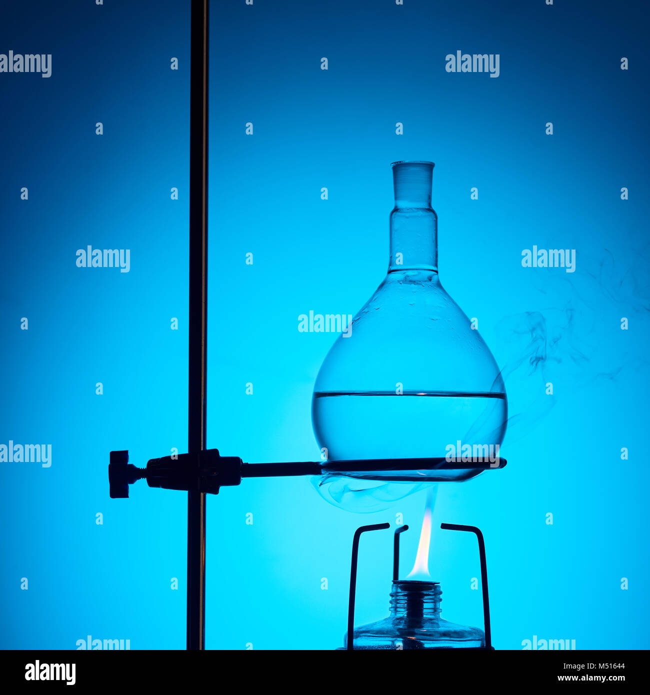 warming up liquid for chemical test isolated on blue Stock Photo - Alamy