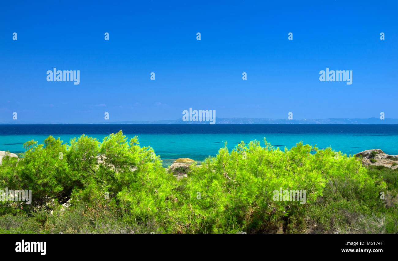 Blue sea shore under clear sky Stock Photo - Alamy