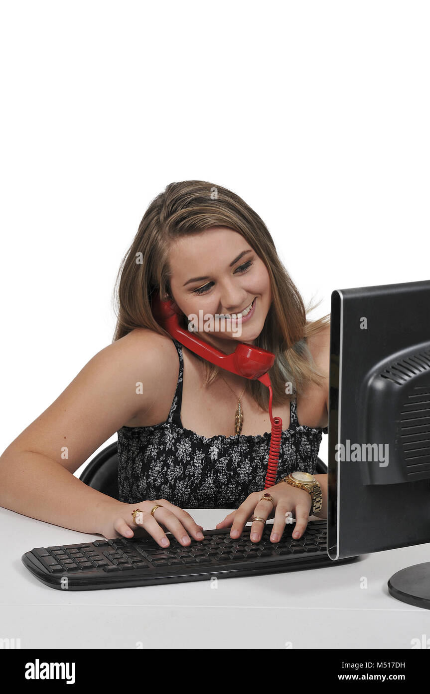 Woman on desktop computer and phone Stock Photo - Alamy
