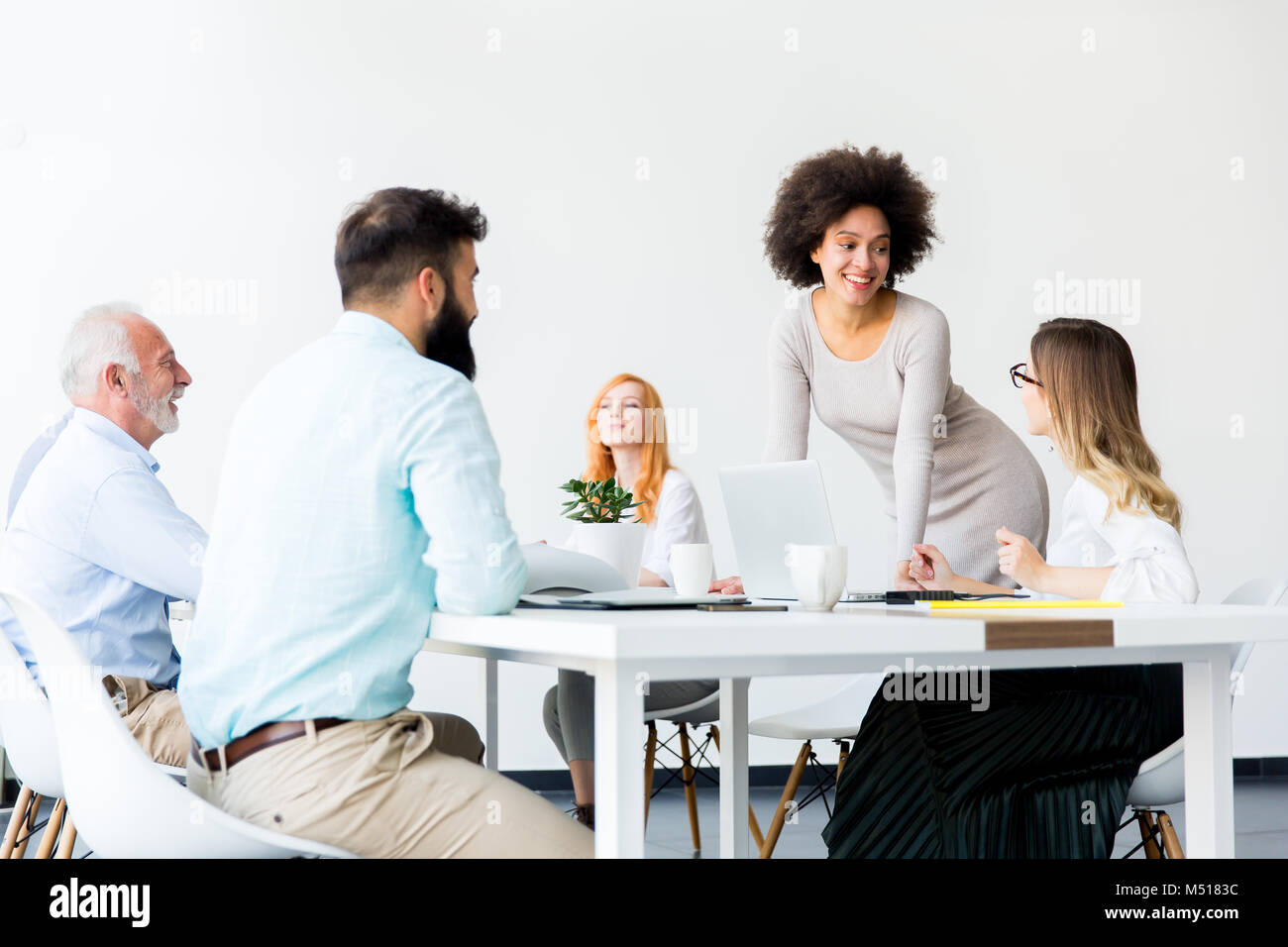 View at business people around table during staff meeting in the office ...