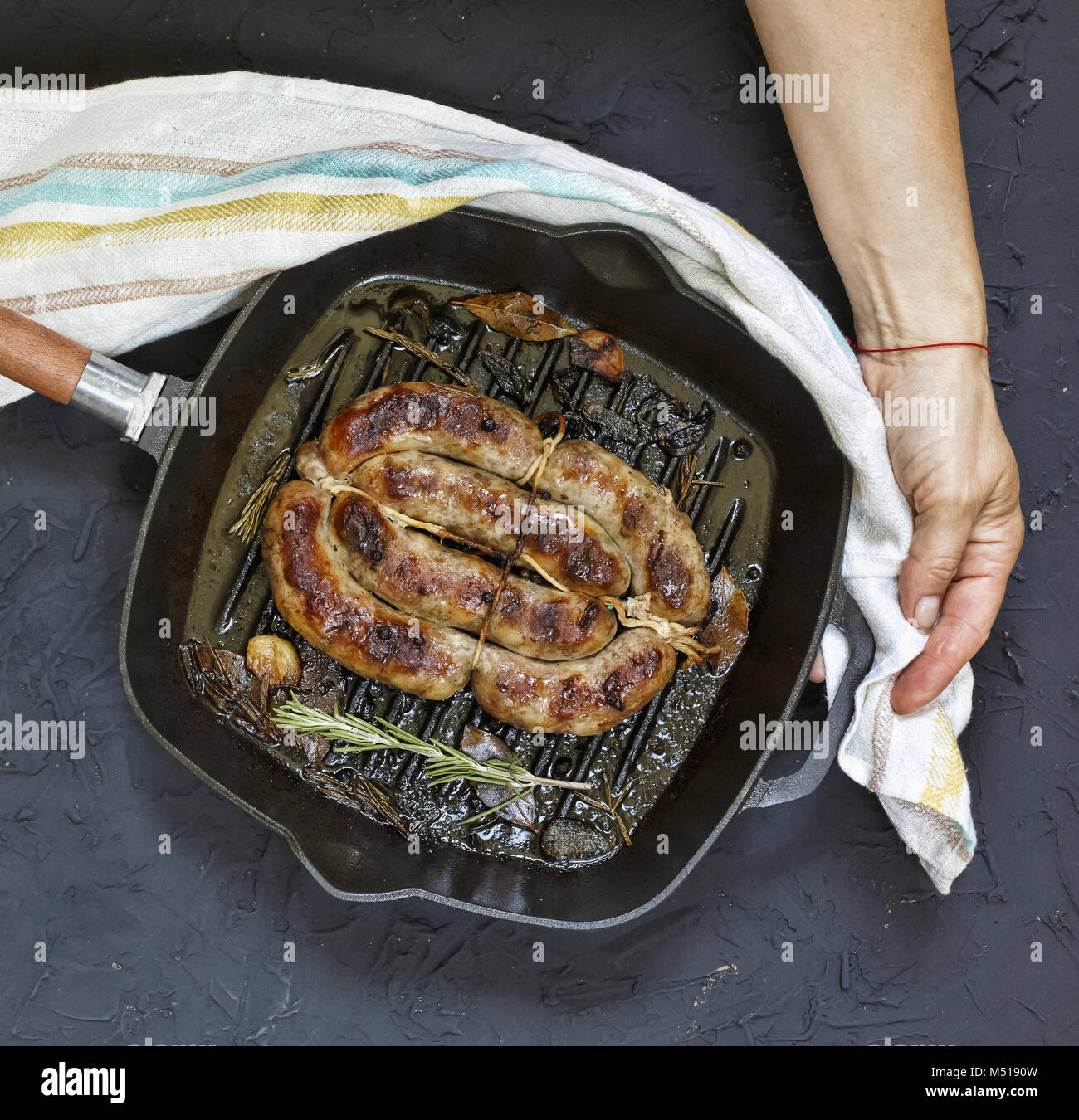 Woman cooking tasty sausage hi-res stock photography and images - Alamy