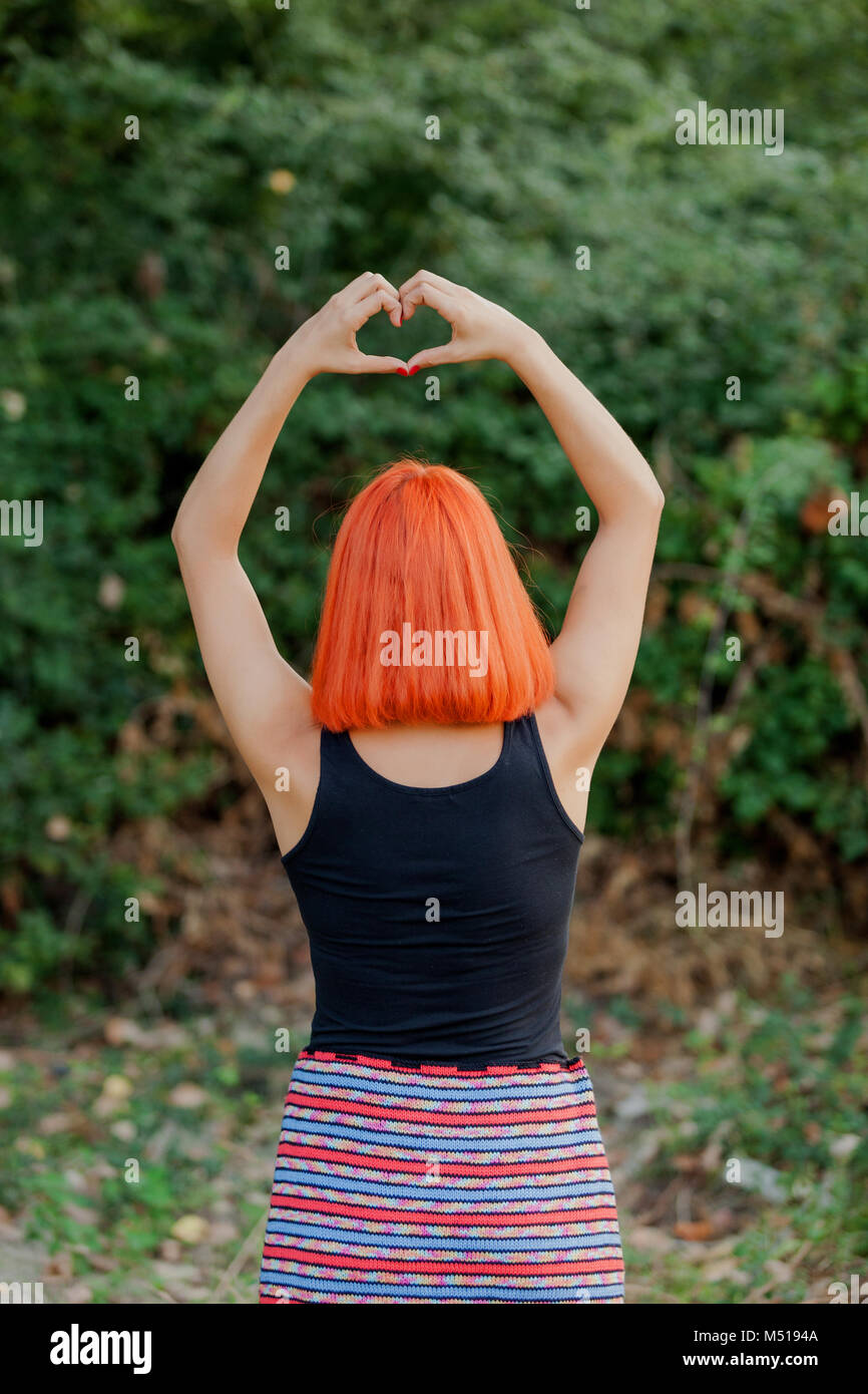 Girl making a heart shape symbol for love Stock Photo - Alamy