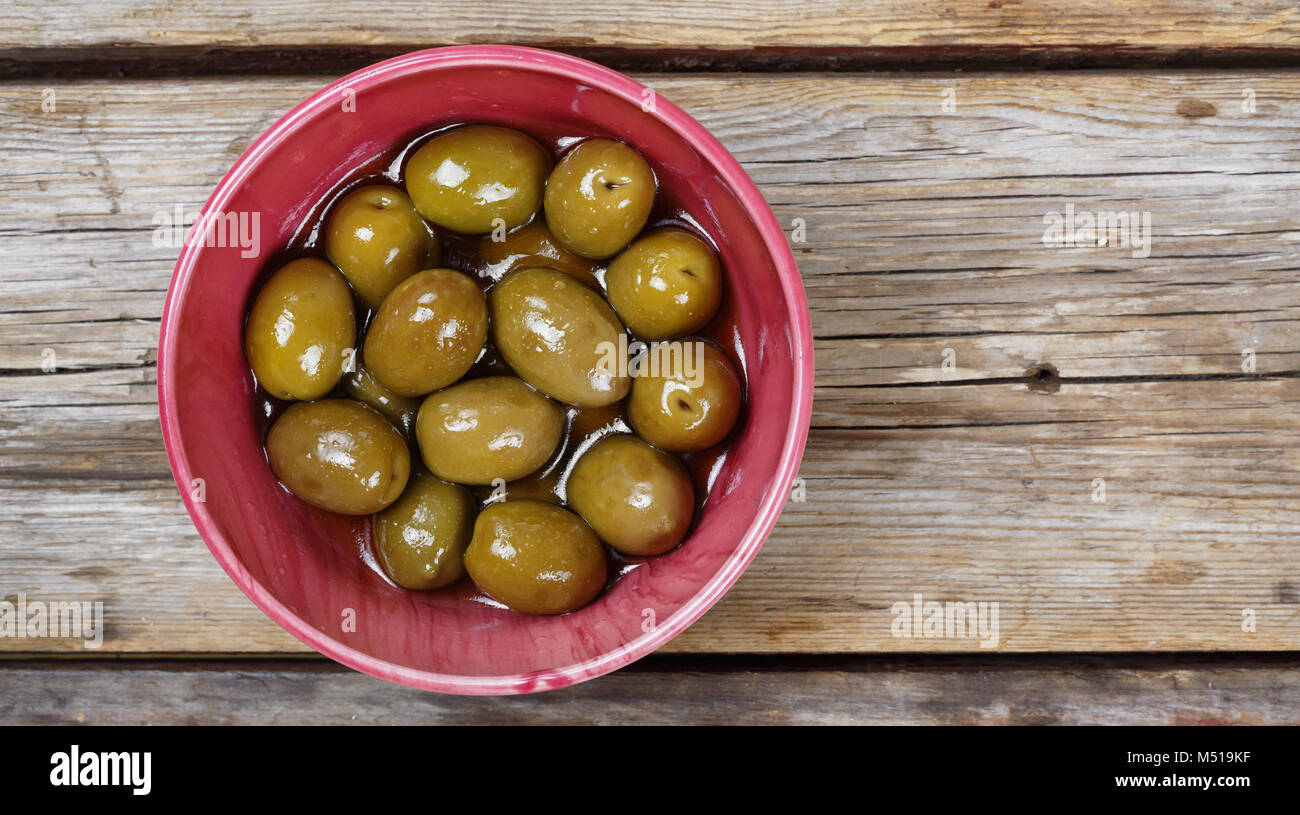 Delicious Olives on a wooden background. View from above Stock Photo ...