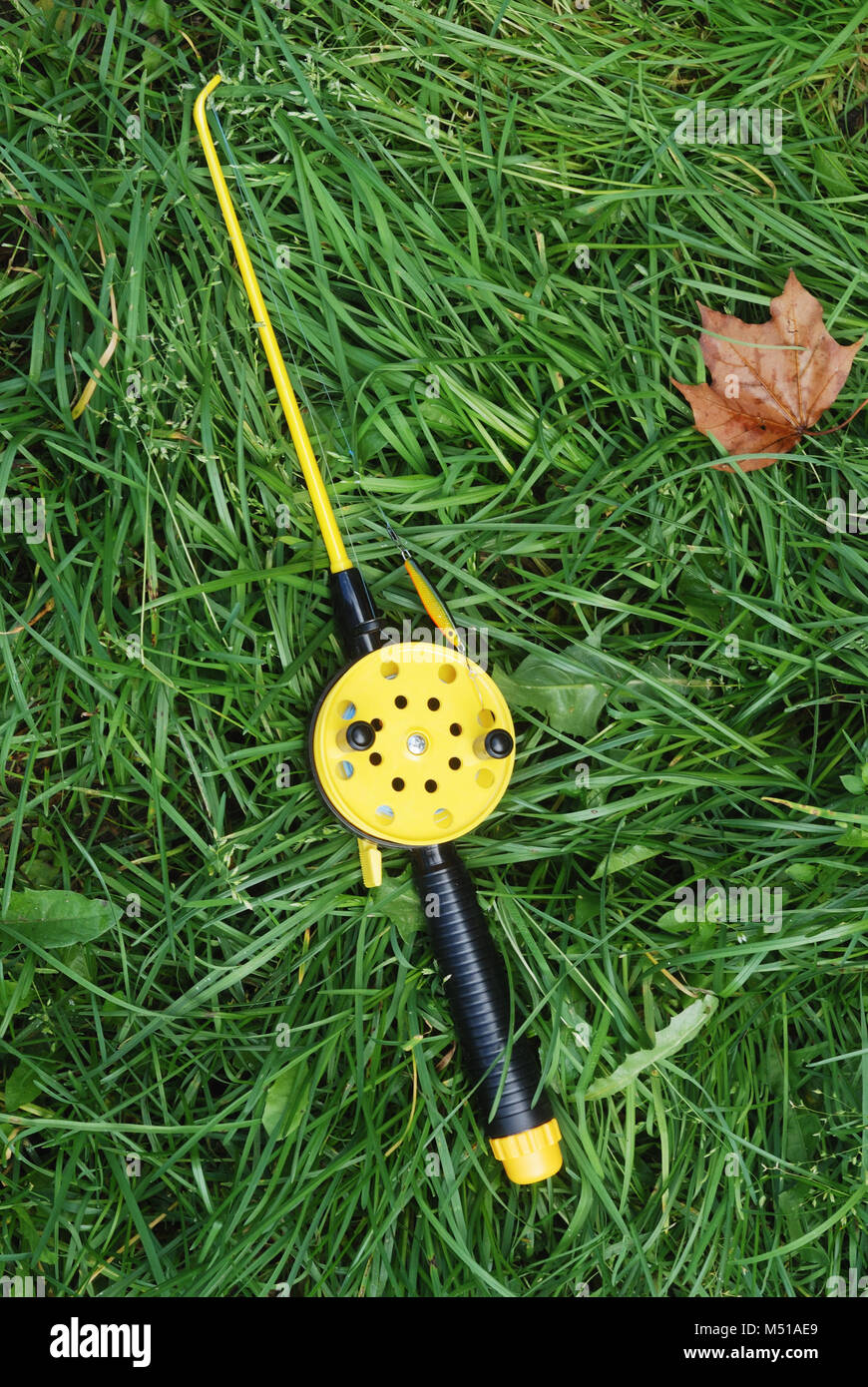 fishing rod with yellow reel Stock Photo - Alamy
