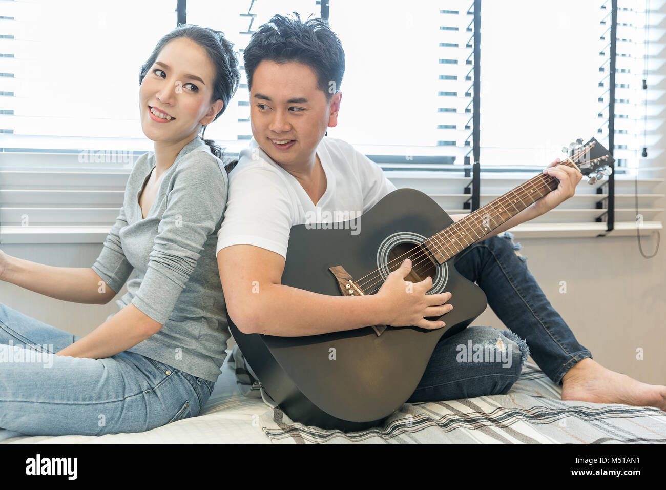 Young Couples playing guitar Stock Photo - Alamy
